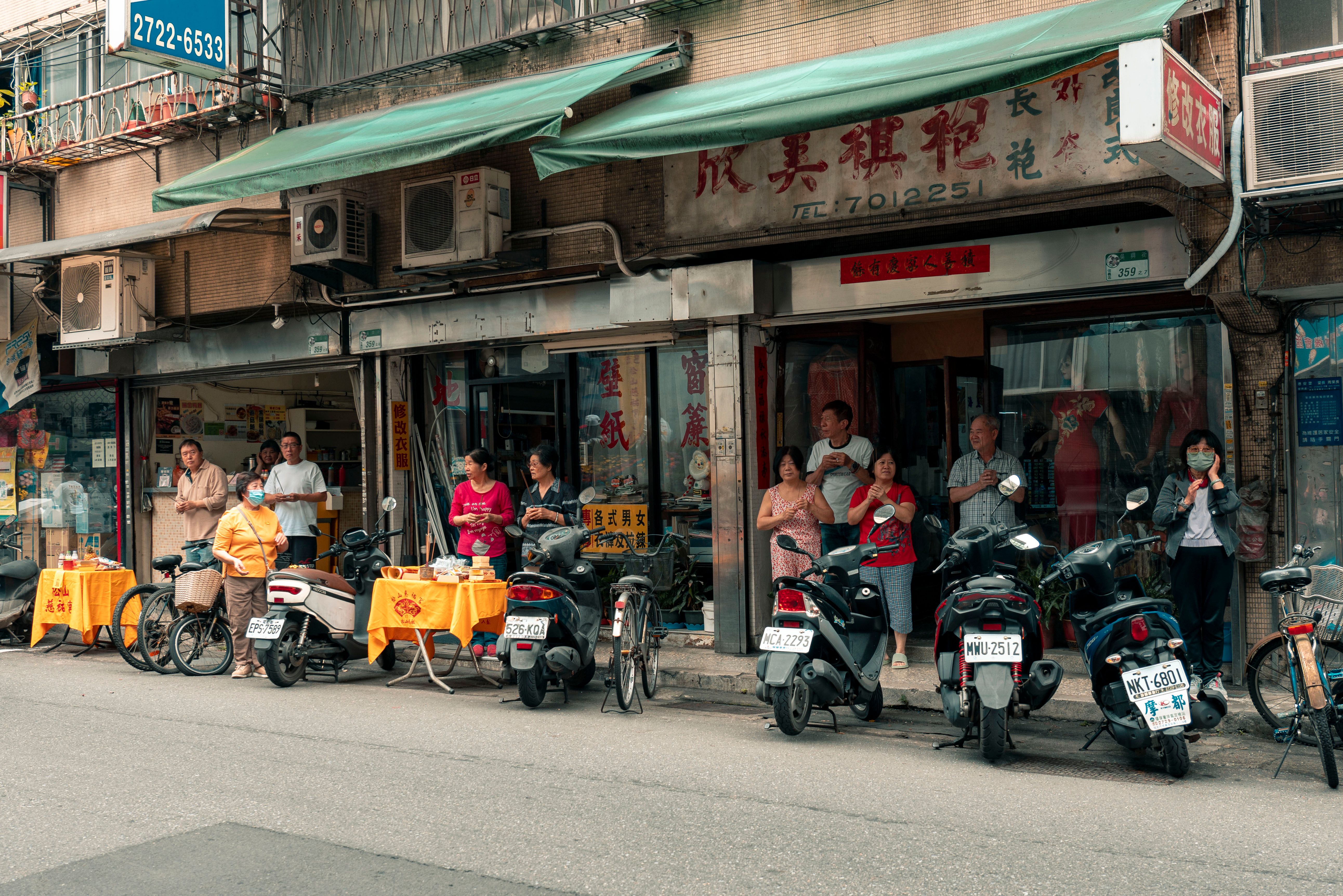 Curious People Standing along the Street behind a Row of Parked ...