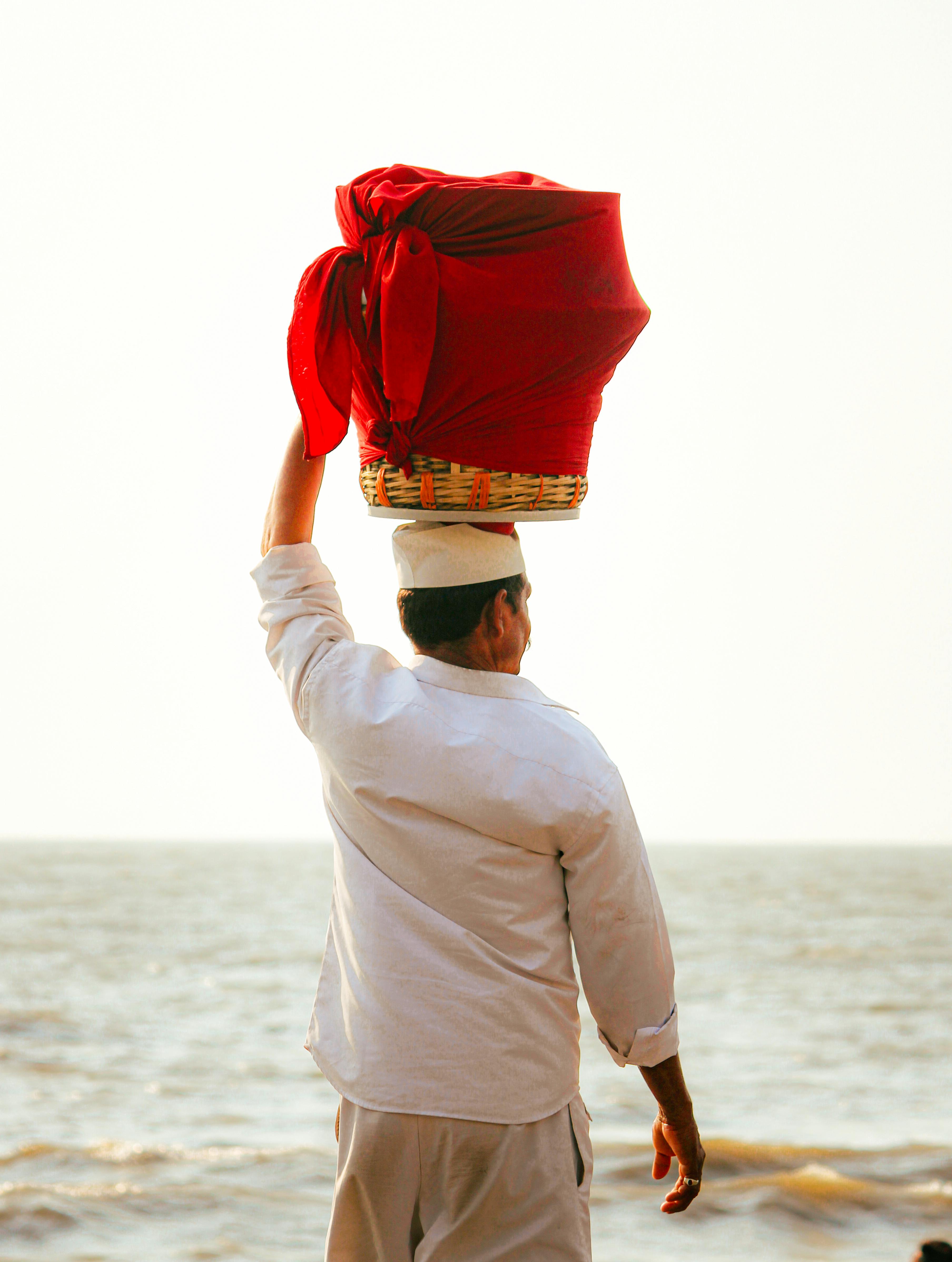 A Man with a Pitcher on a Beach · Free Stock Photo