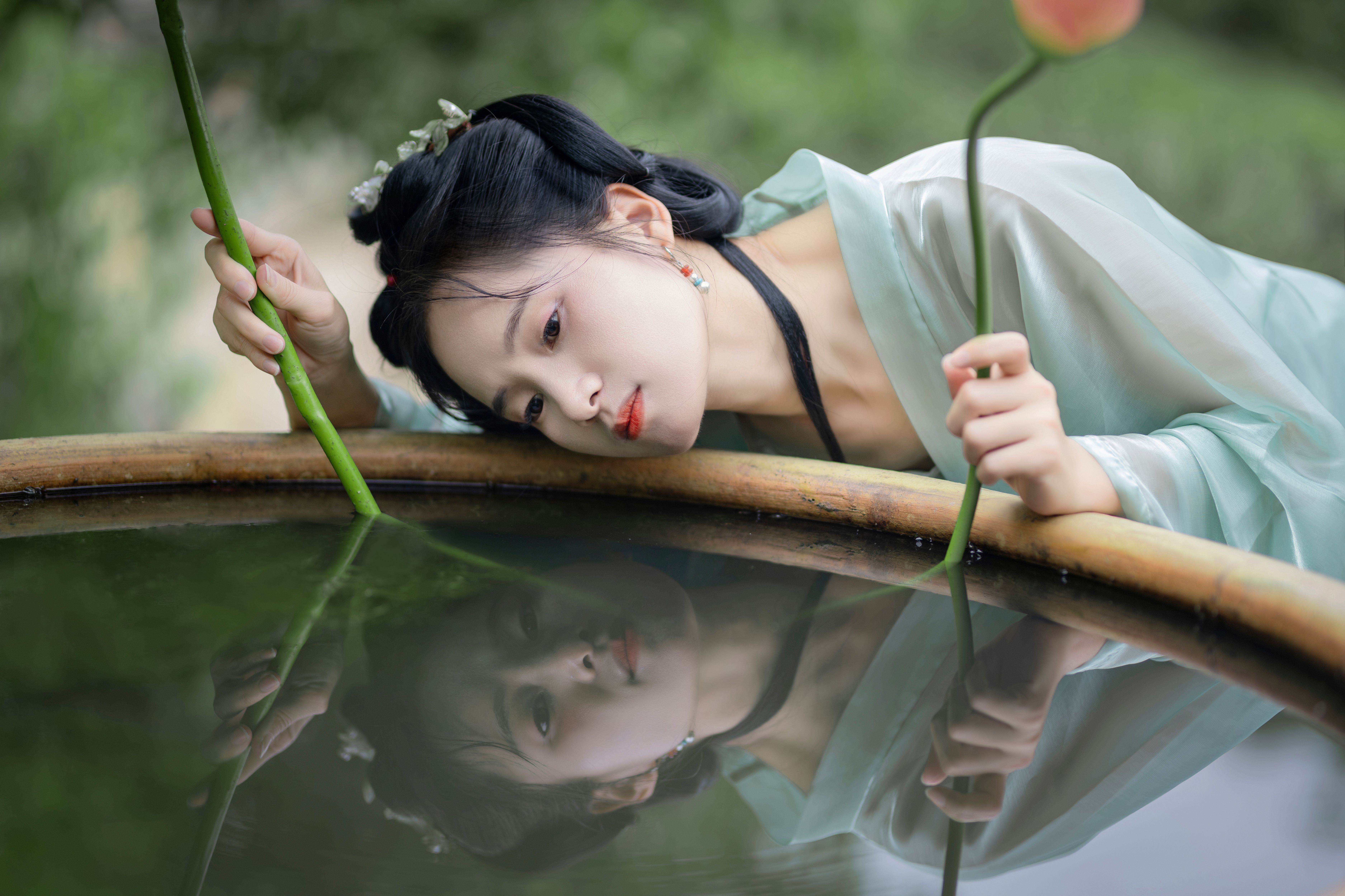 A Woman Looking at her Reflection in Water · Free Stock Photo