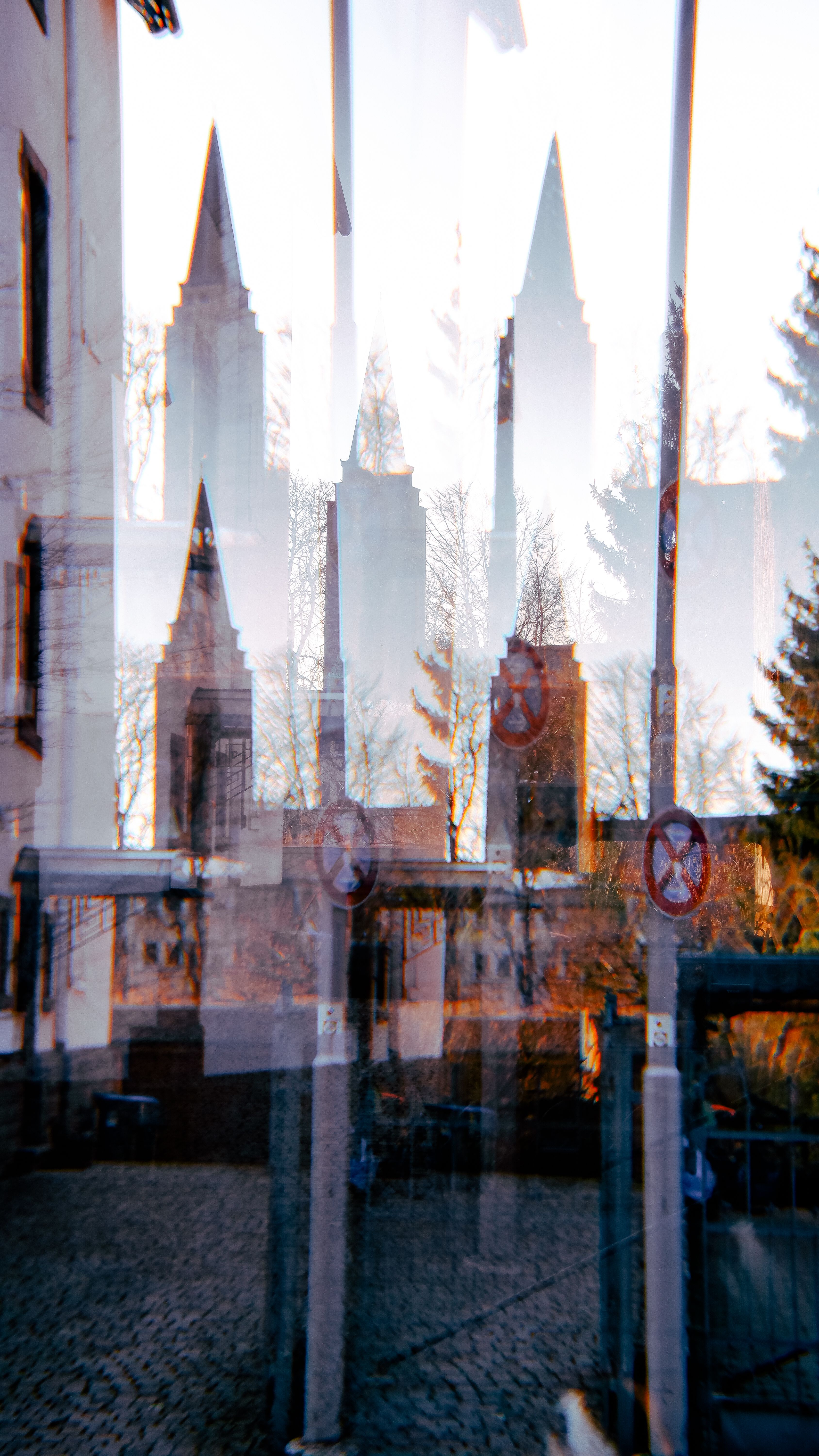 Reflection of Building with Towers in Window · Free Stock Photo