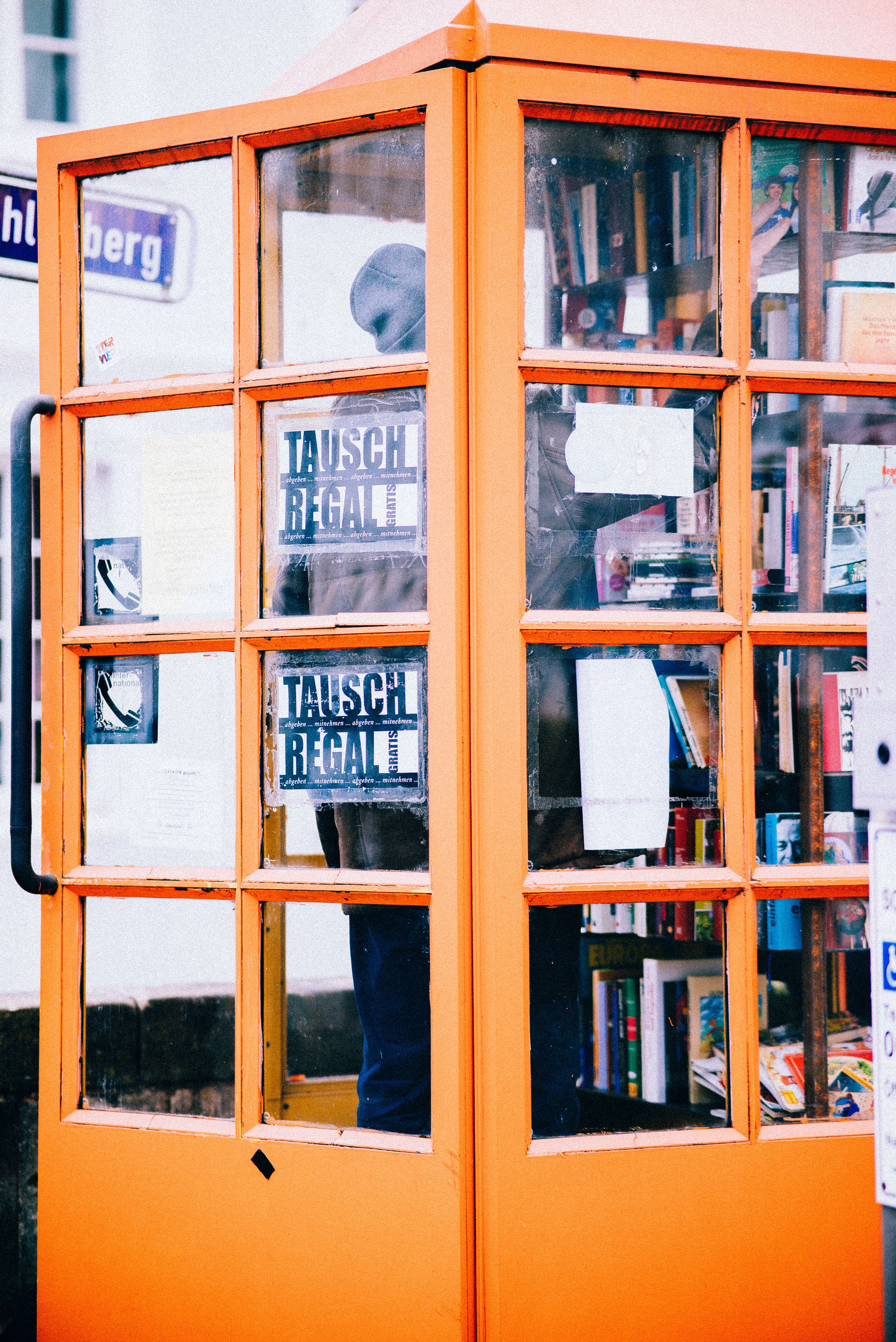 Man Standing in a Booth with Books · Free Stock Photo
