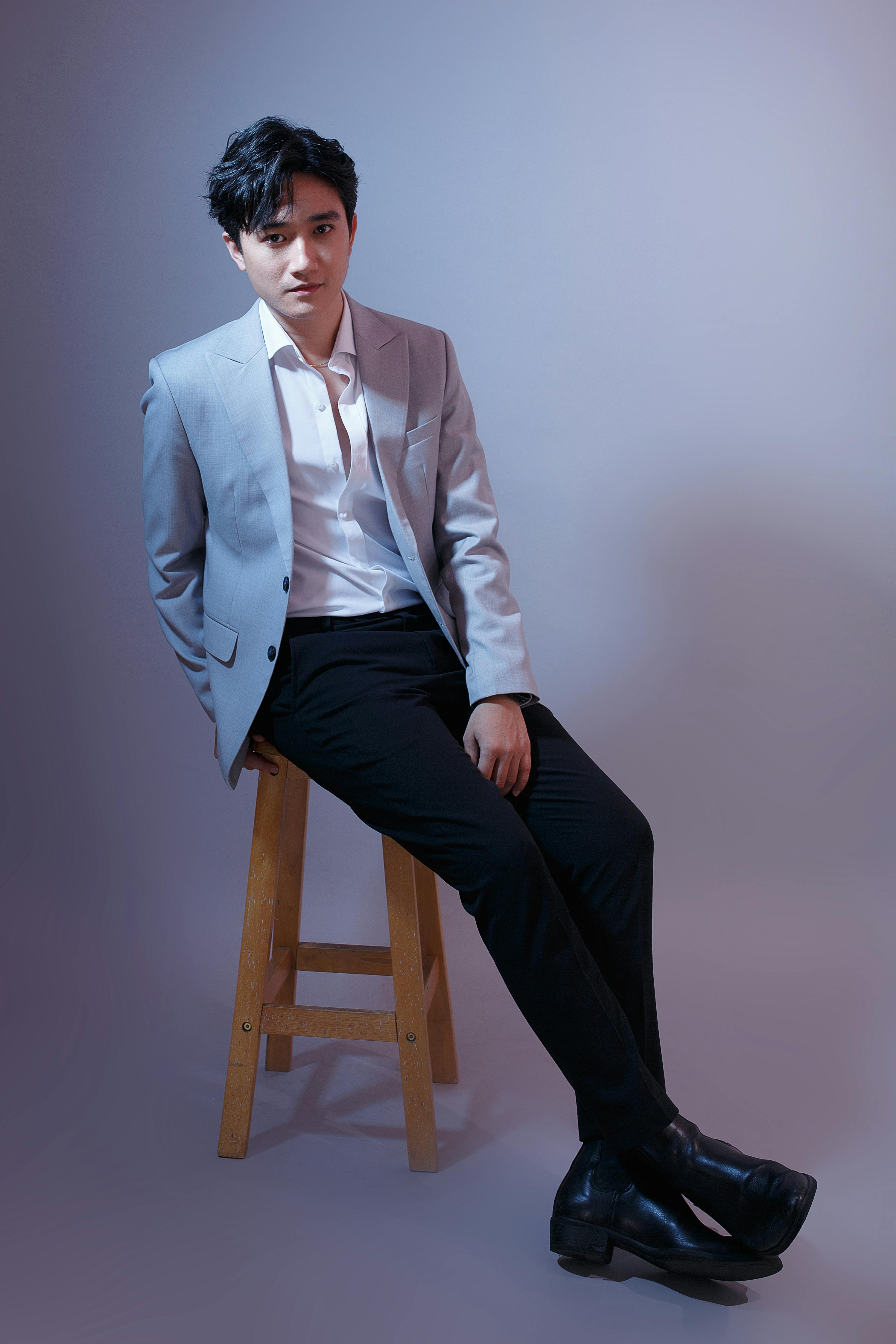 Man Sitting and Posing on Chair · Free Stock Photo