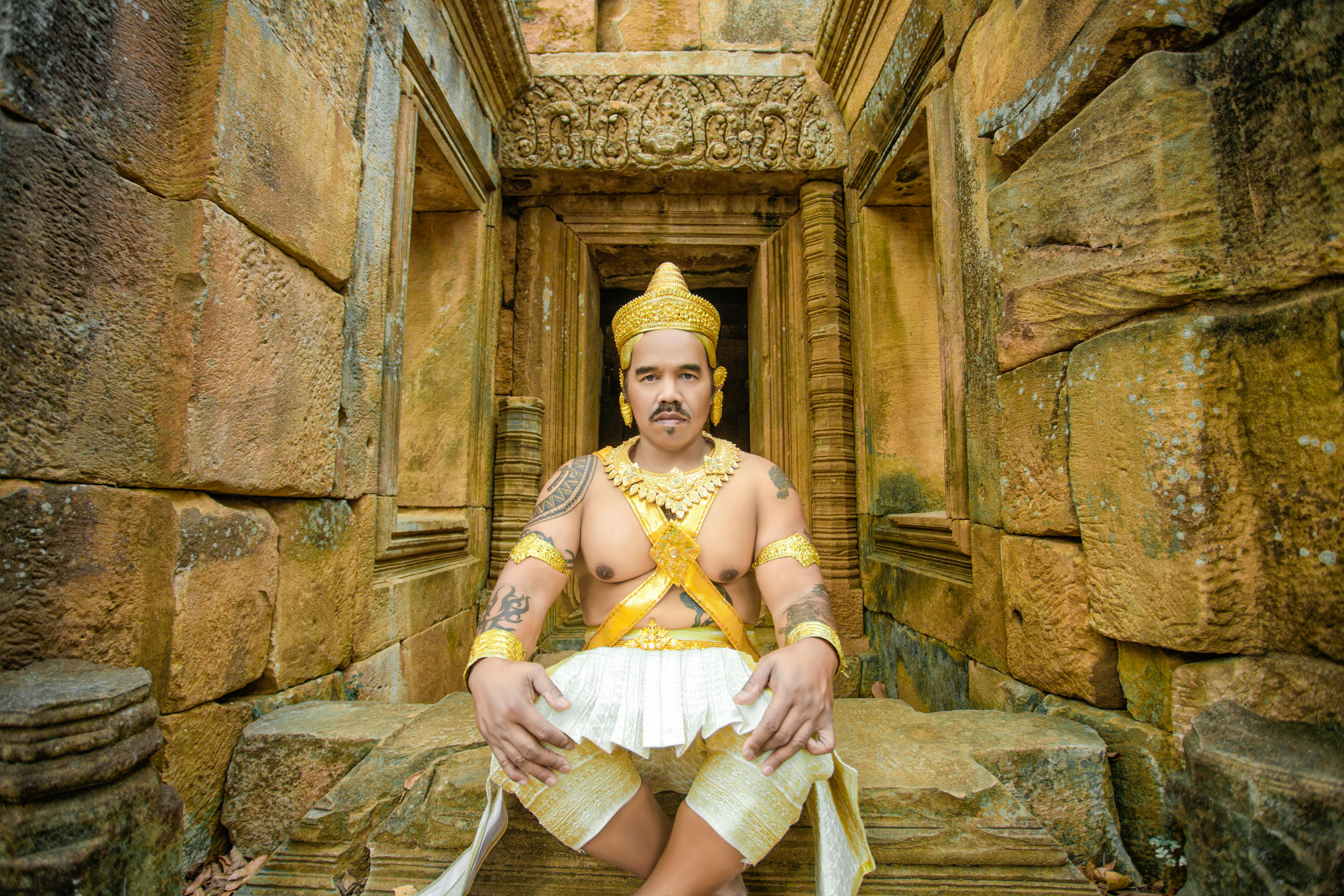 Man Sitting and Posing in Golden, Traditional Clothing in Ancient ...
