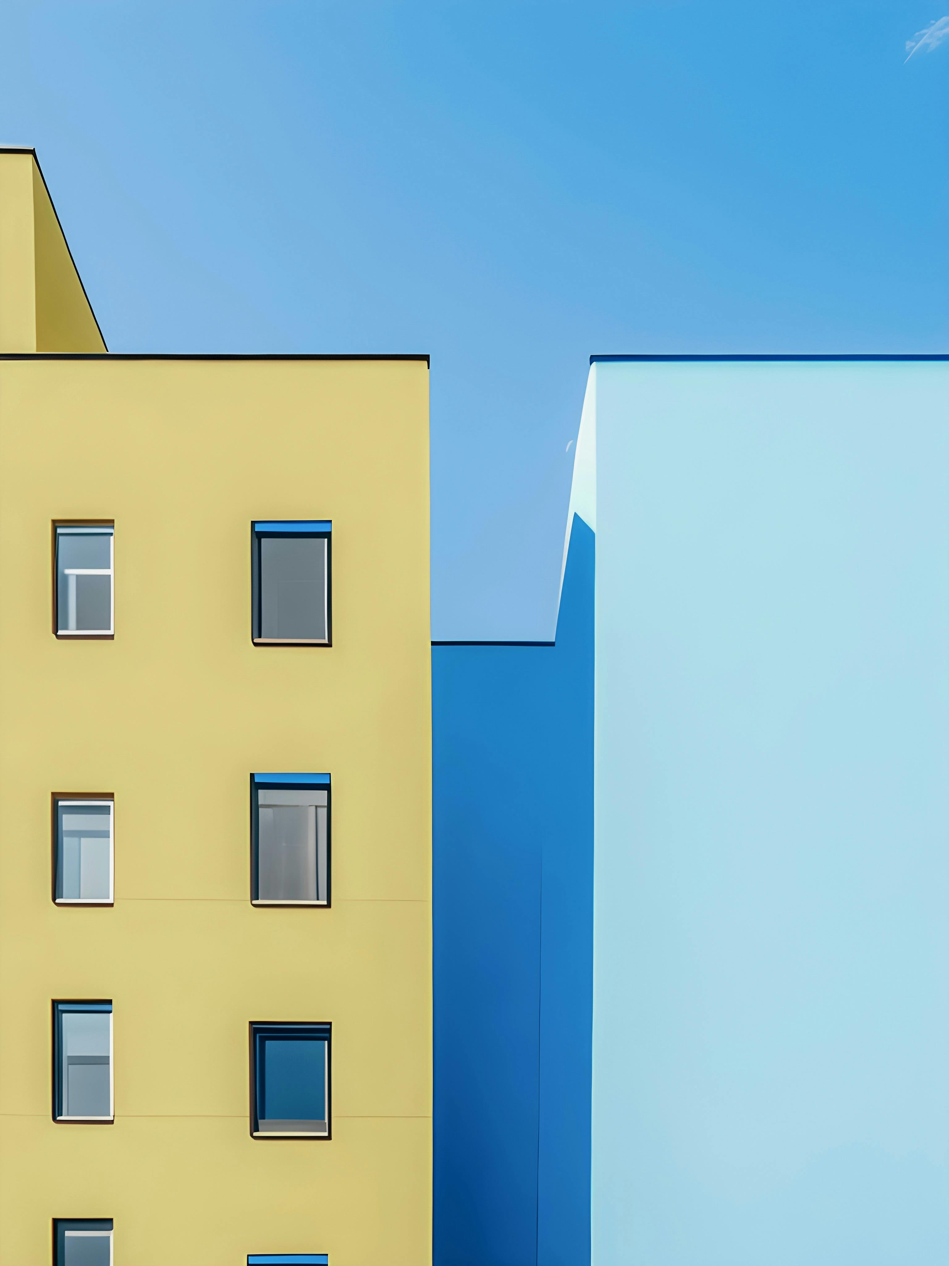 Yellow and Blue Walls of Buildings with Apartments · Free Stock Photo