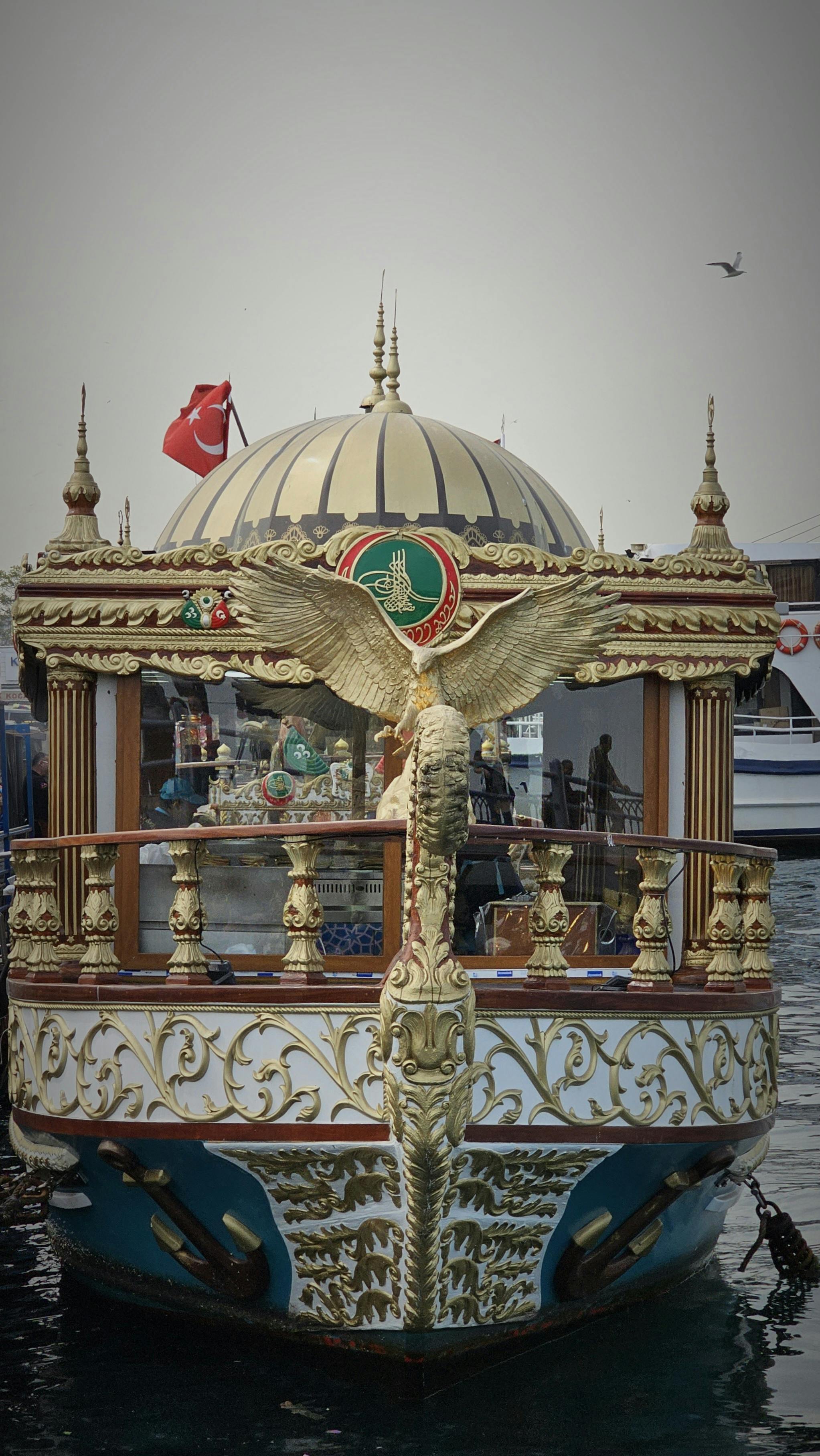 Ornate Gold Boat with Bird Statue on Prow · Free Stock Photo