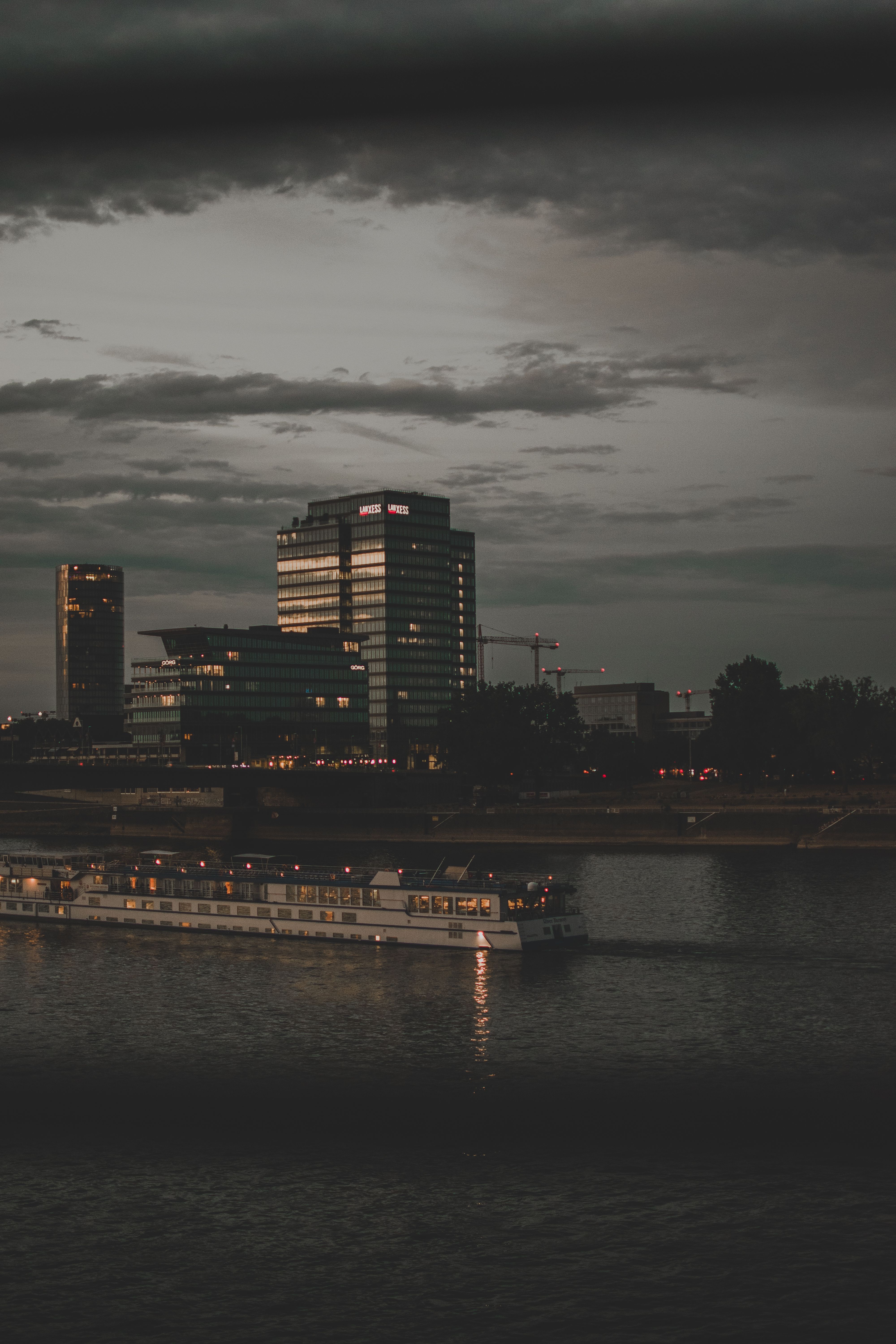 Gray Image of a Waterfront and River Bus at Dusk · Free Stock Photo