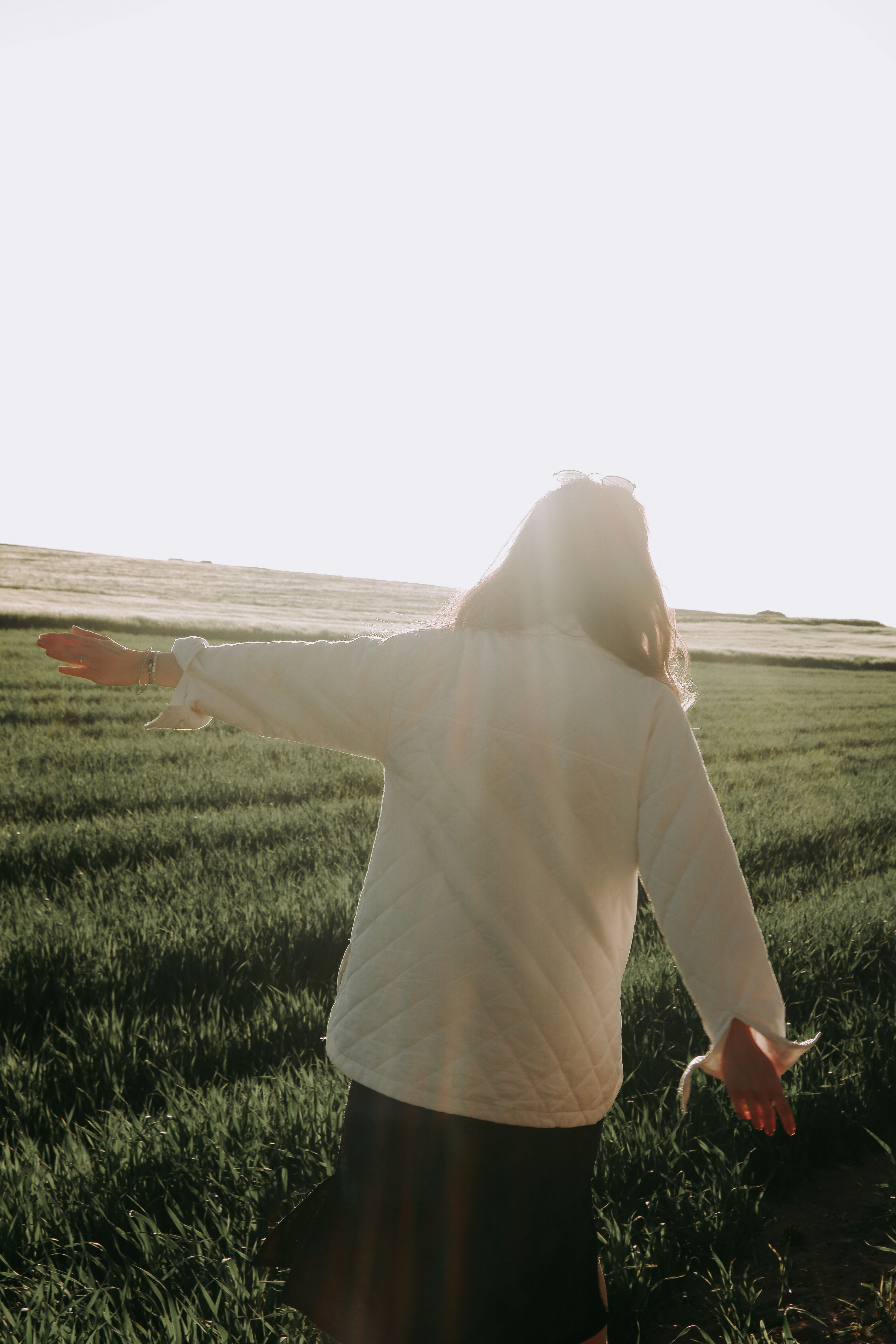 Back View of a Woman with Her Arms Spread on a Field in Summer · Free ...