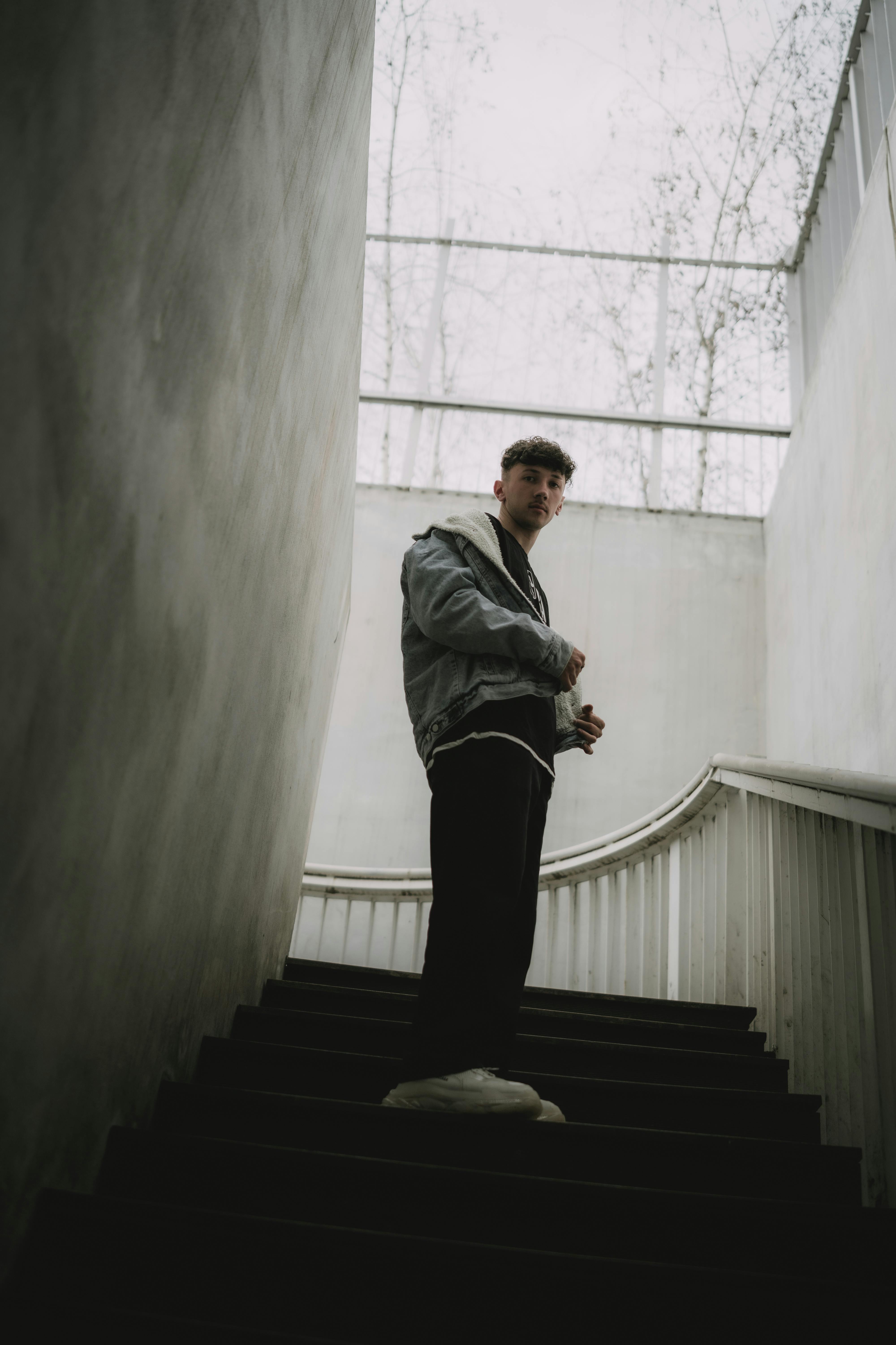 Male Model Standing on a Staircase · Free Stock Photo