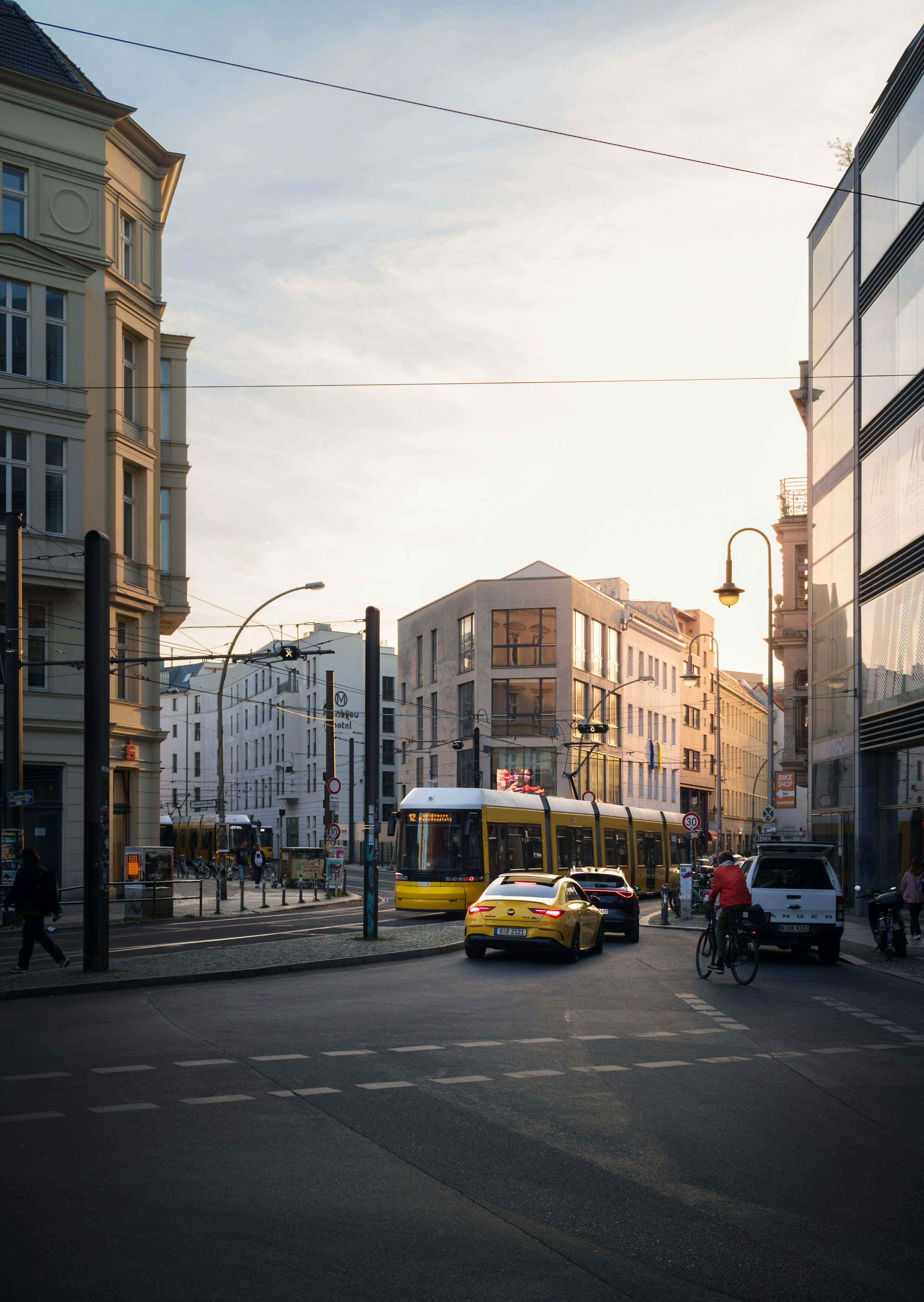 A city street with a yellow bus and cars · Free Stock Photo