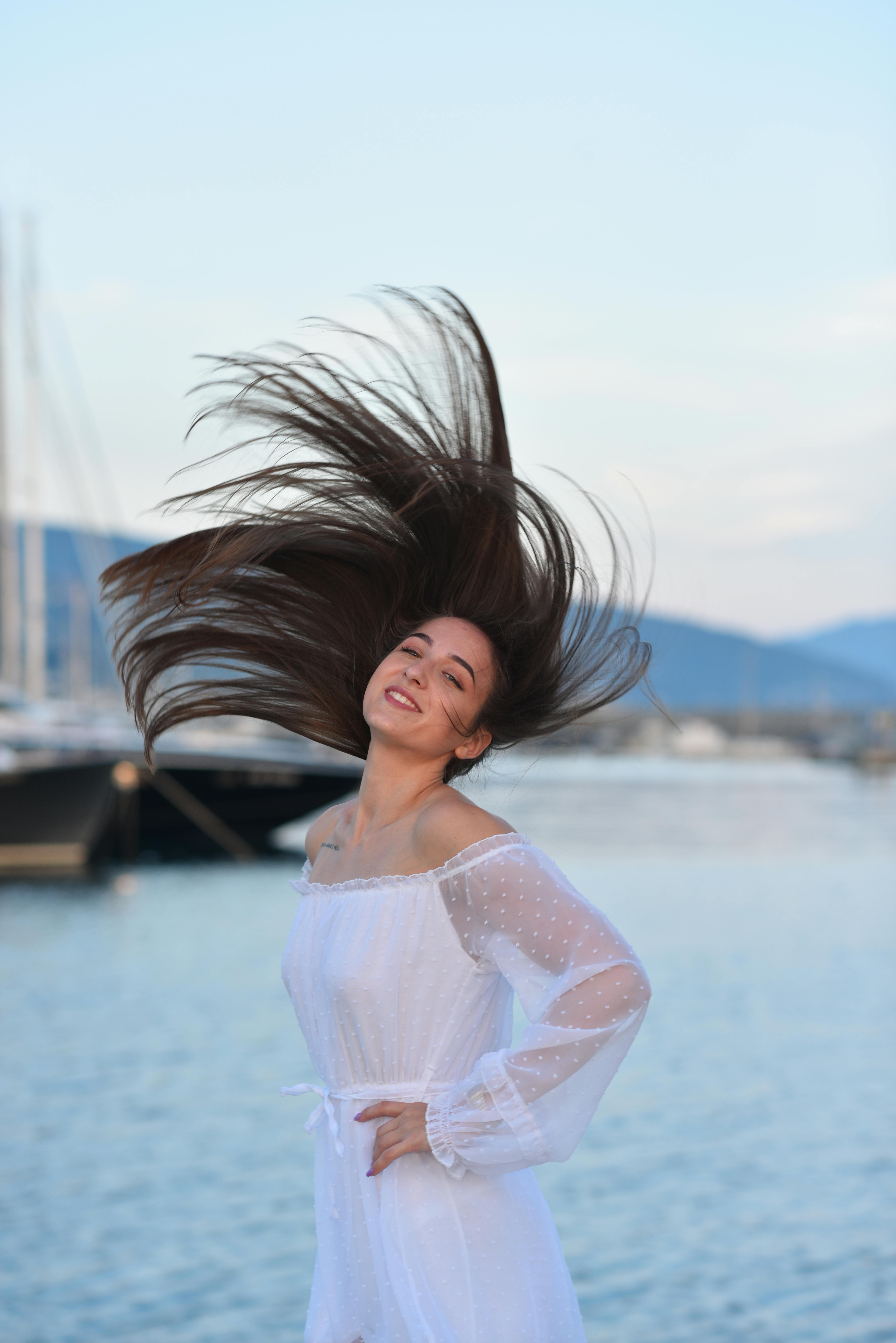 Woman Tossing Hair by Lake · Free Stock Photo