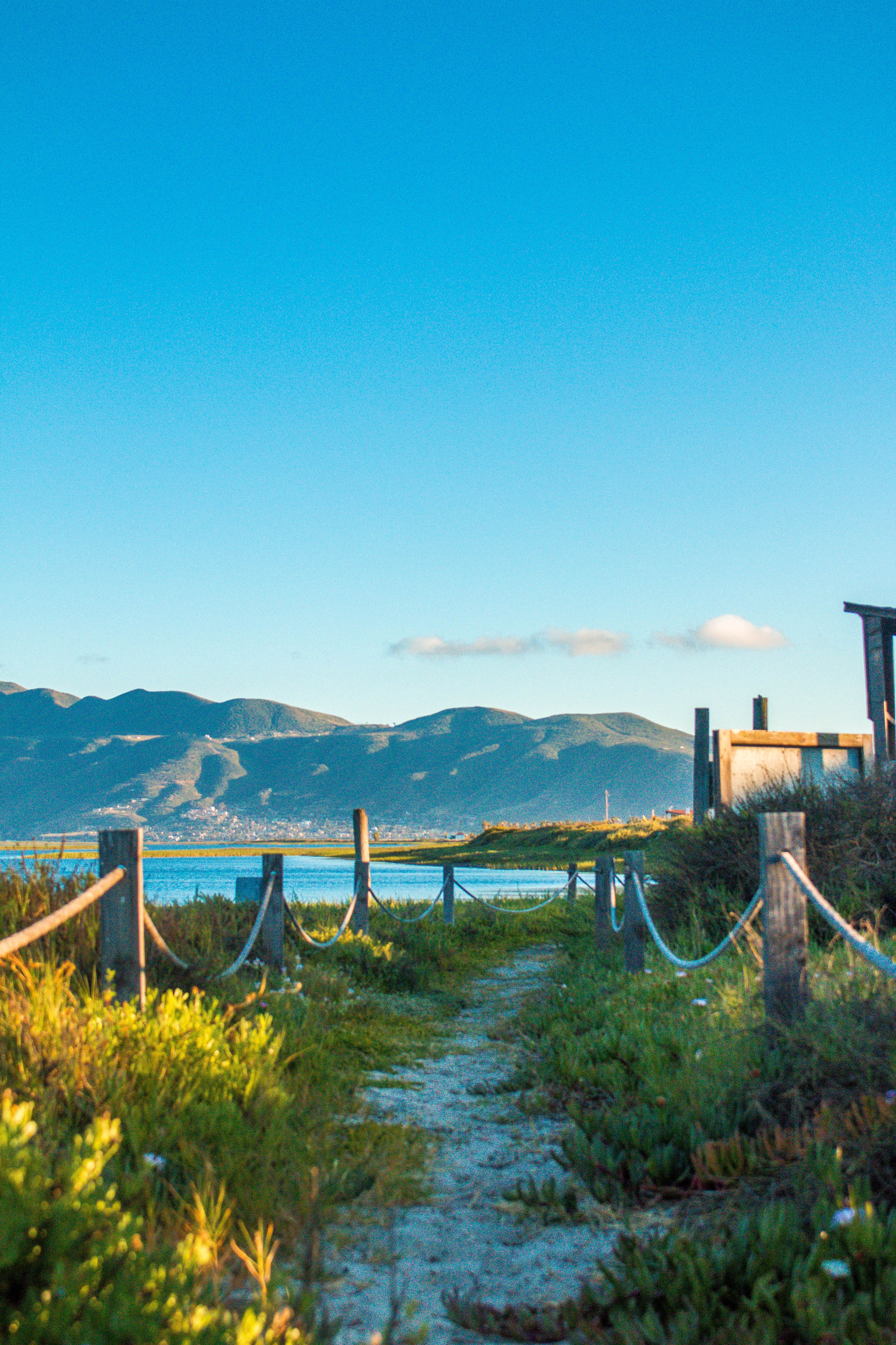 A Trail Leading to the Body of Water and View of Hills in the ...