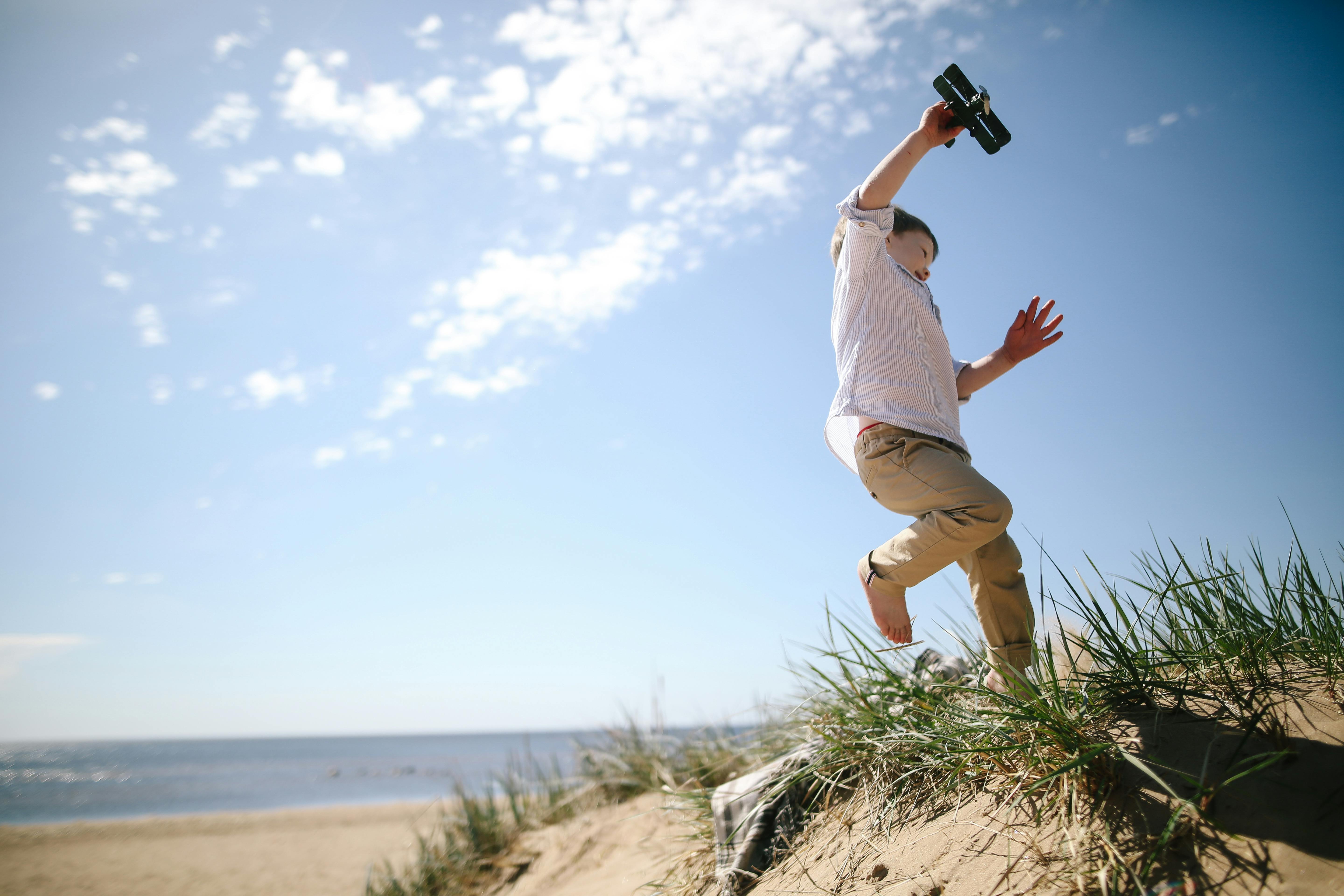 Man Leaping on Seashore · Free Stock Photo