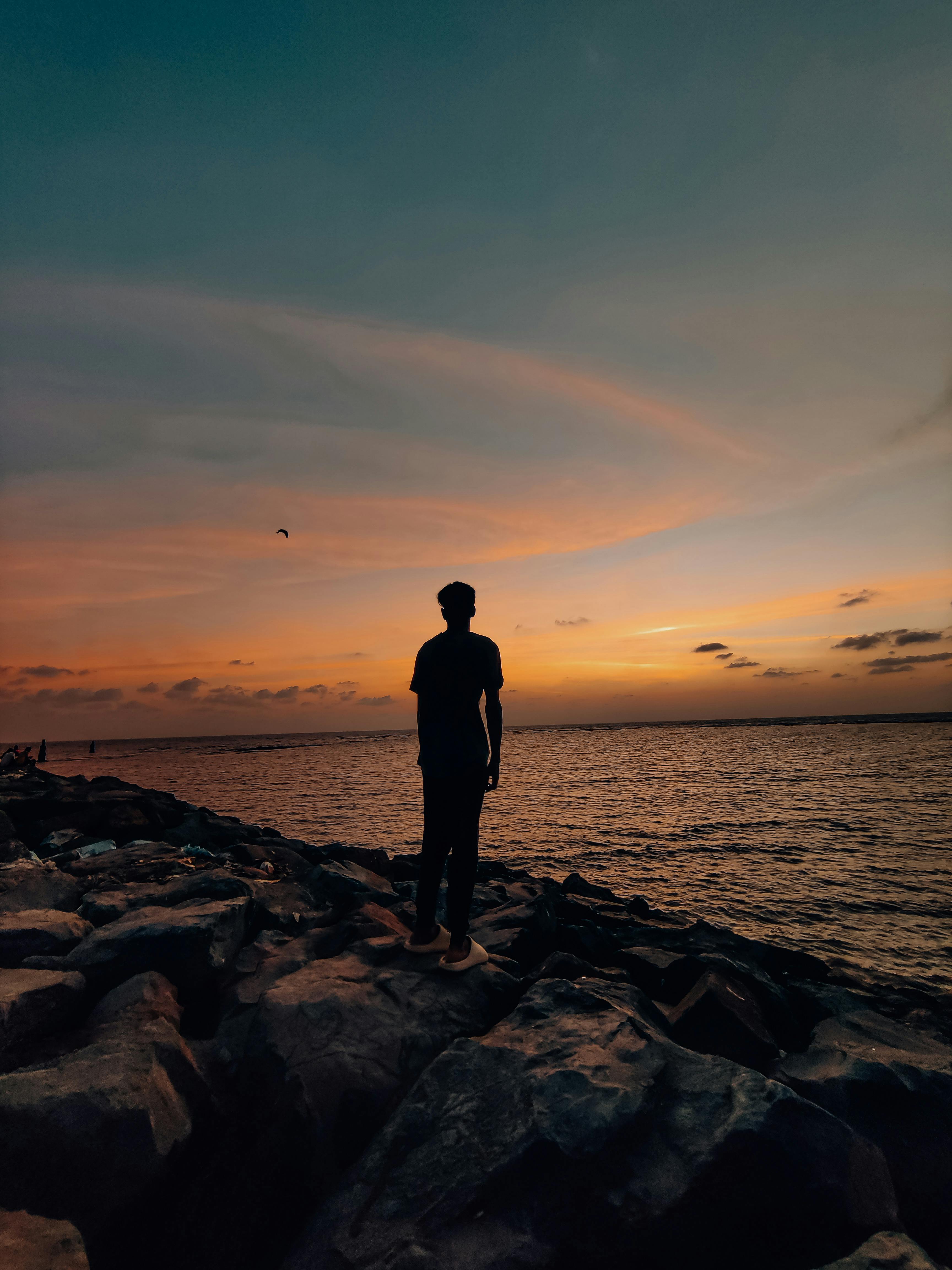 Man Shining a Powerful LED Flashlight into the Sky · Free Stock Photo