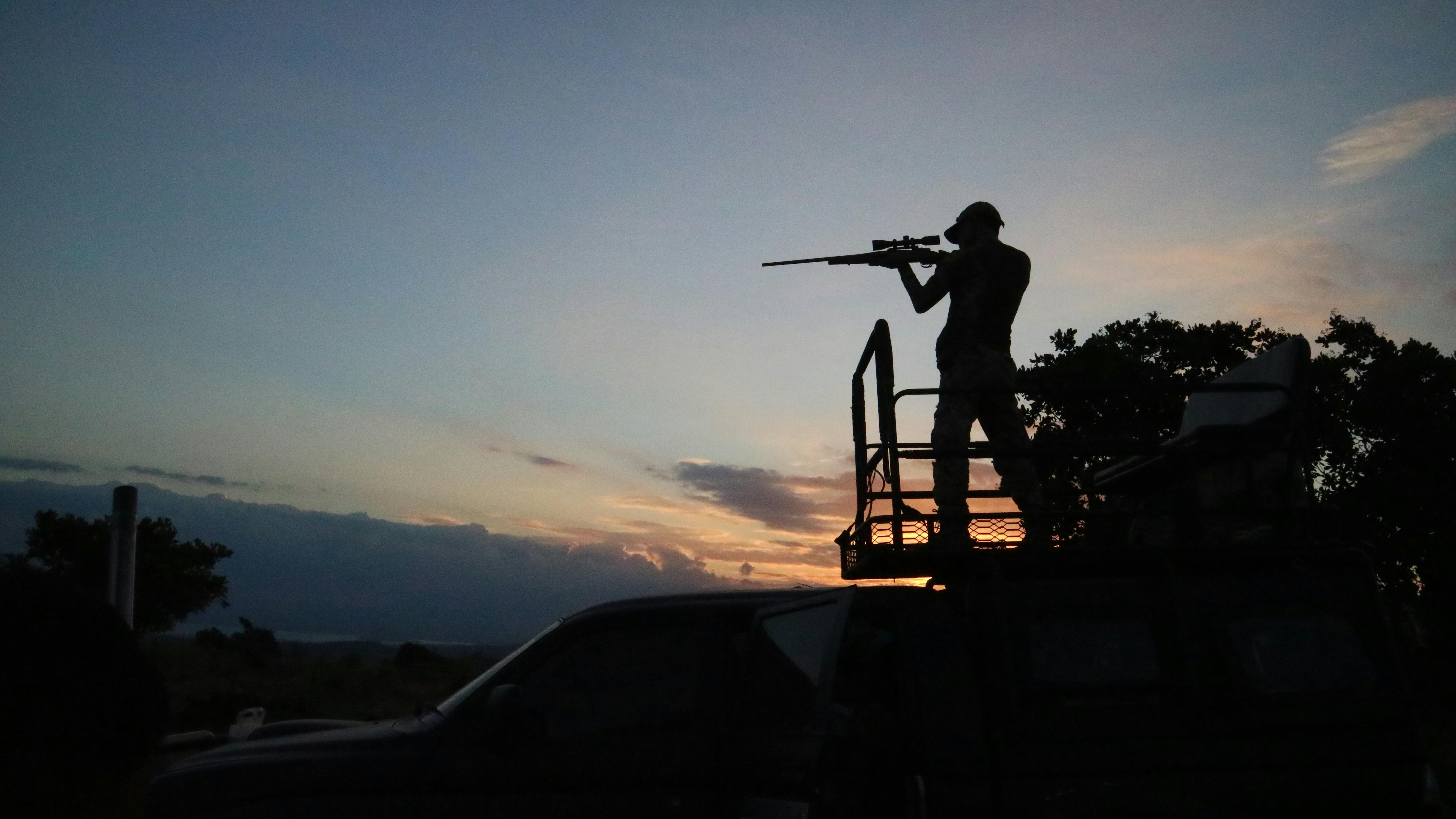 Hunter Standing with Riffle on Pulpit · Free Stock Photo