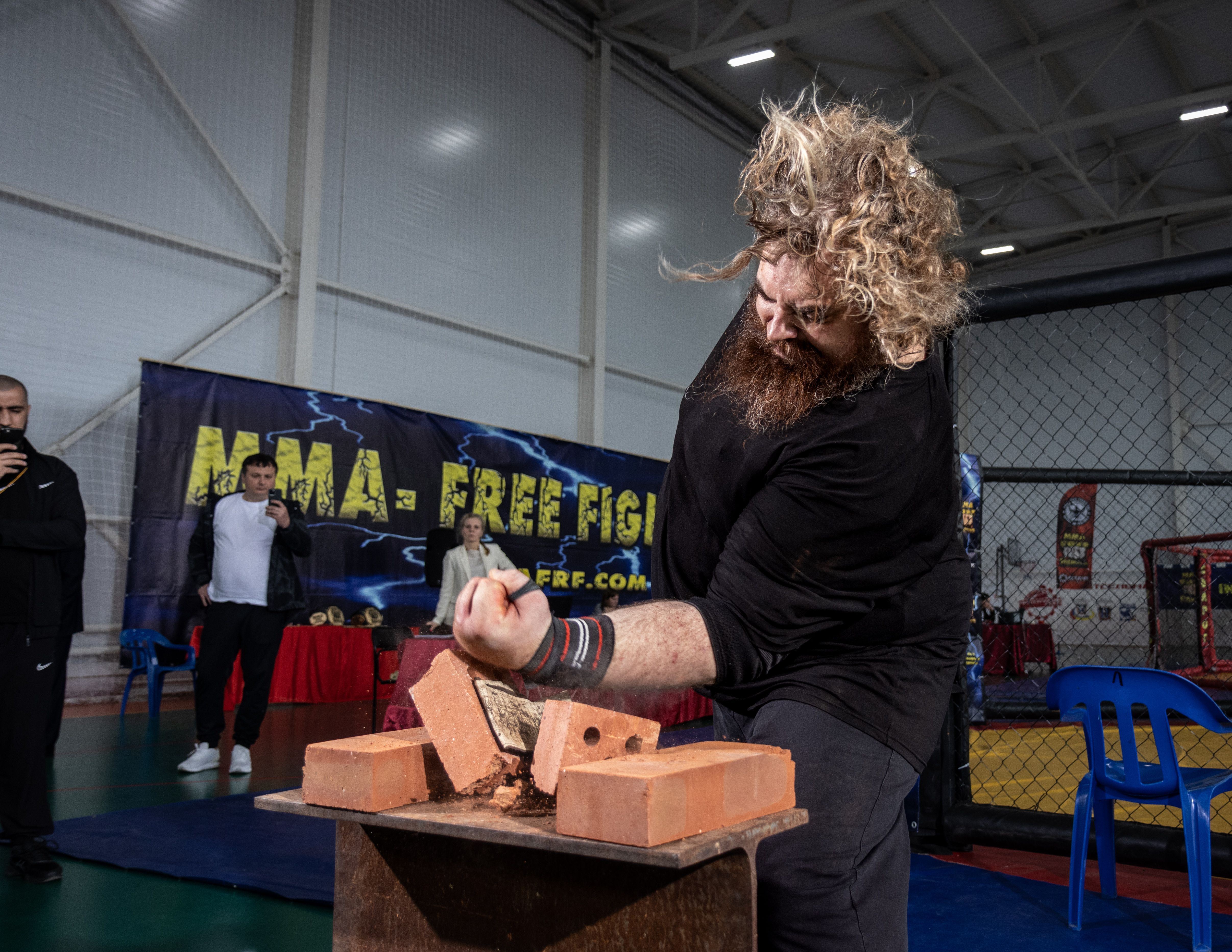 Strongman Breaking Bricks with Fist · Free Stock Photo