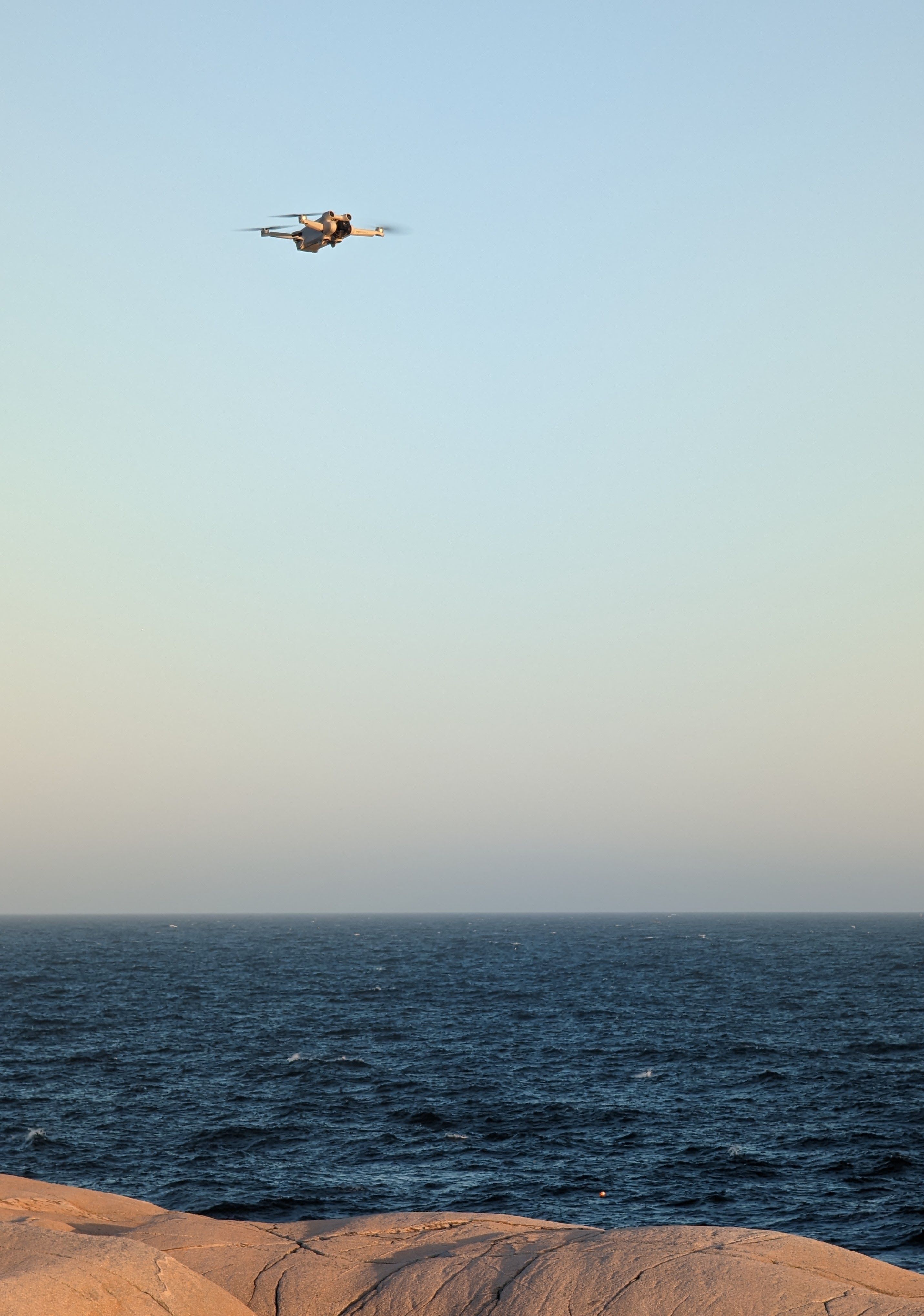 Drone Flying over Rocks on Sea Shore · Free Stock Photo