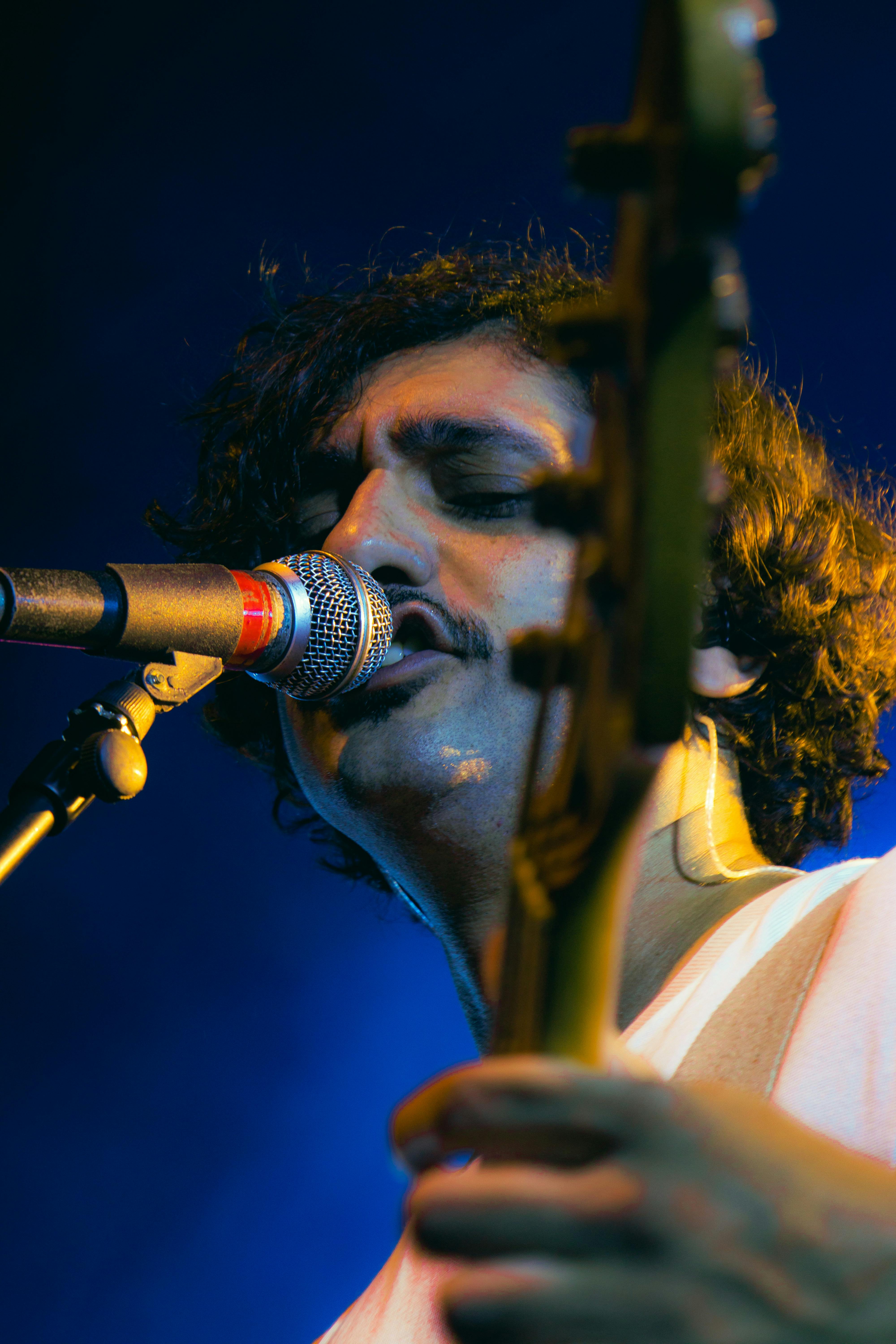 Photo of Man Carrying Acoustic Guitar · Free Stock Photo