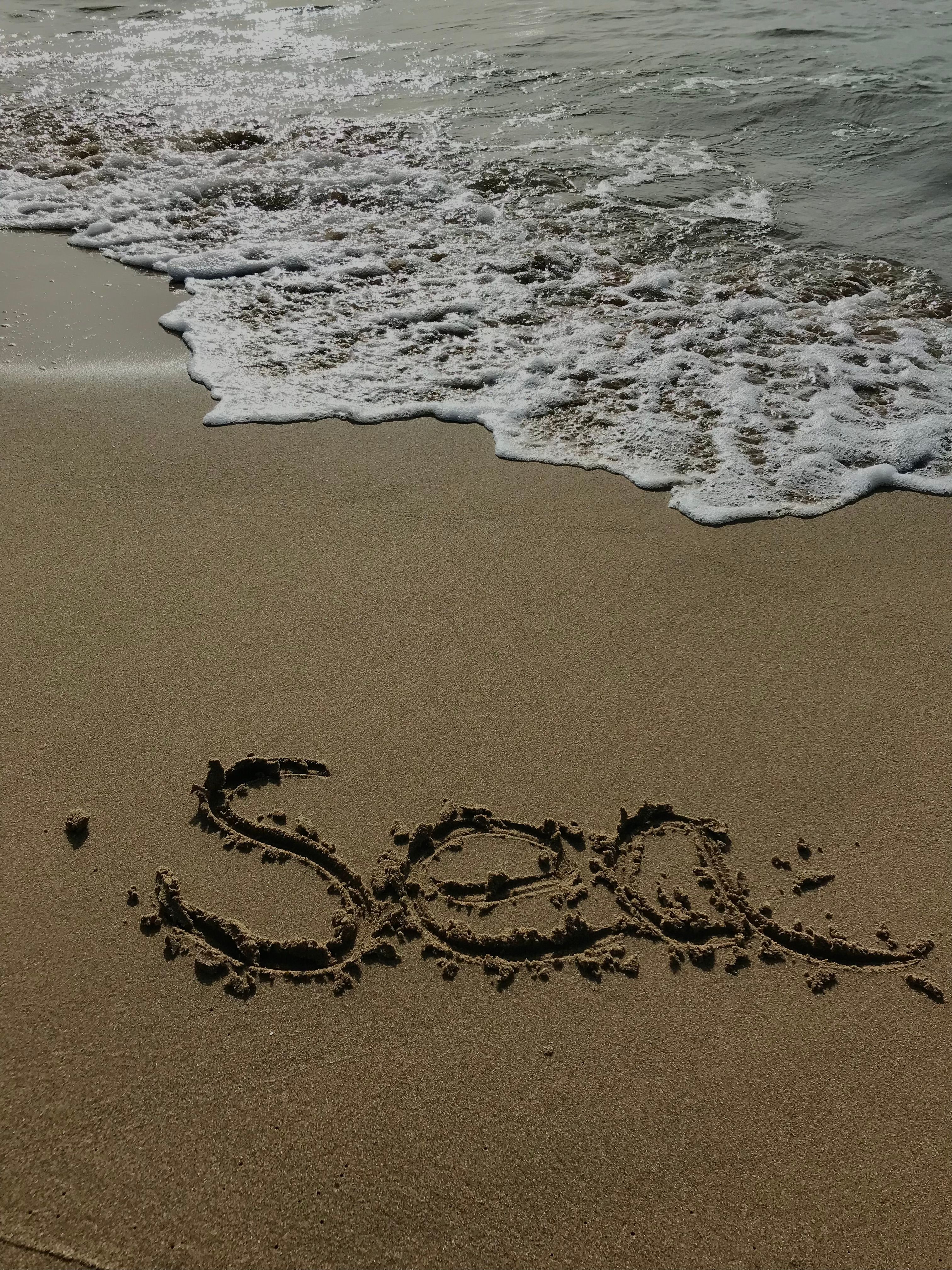 Word Sea Written in Sand · Free Stock Photo