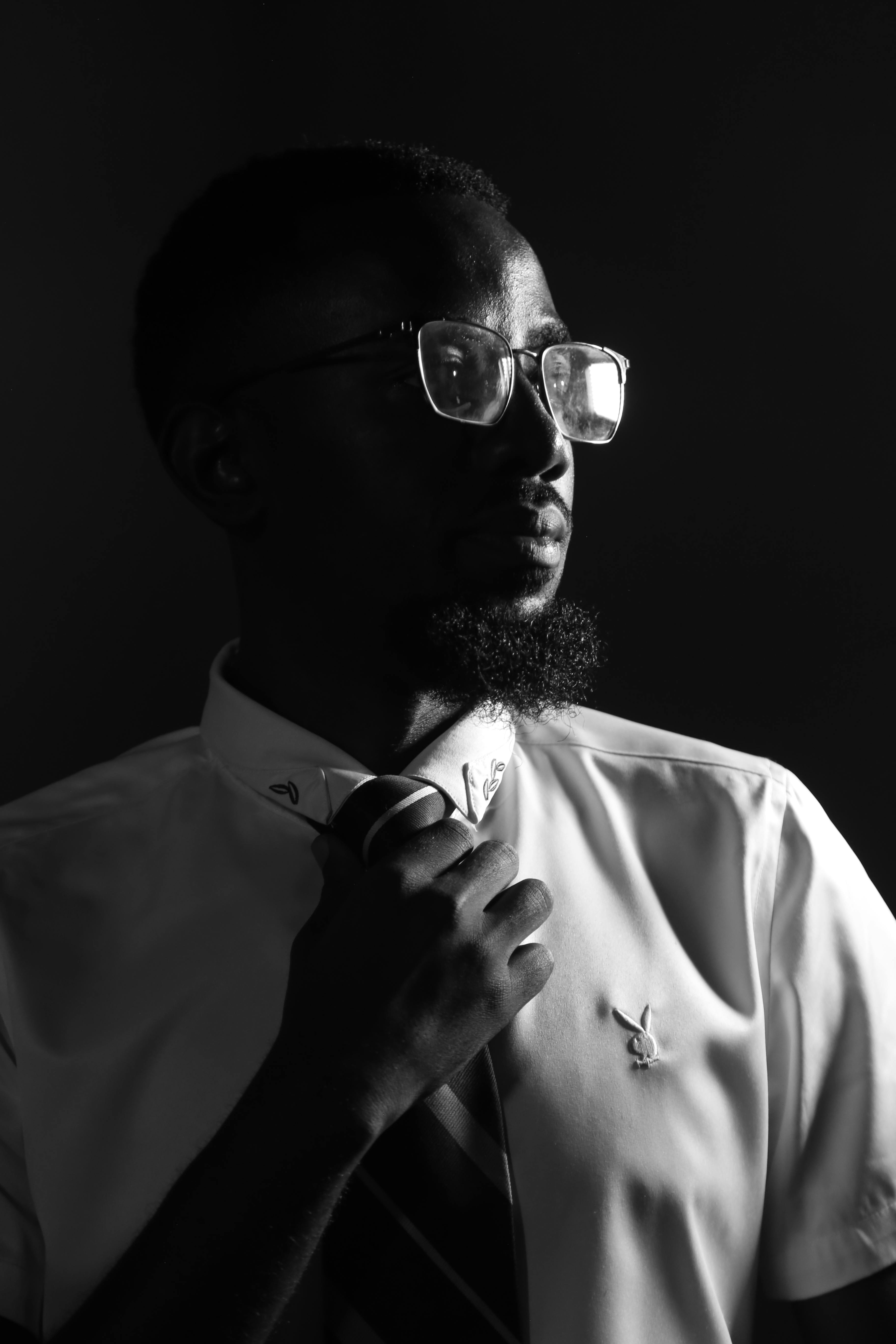 Grayscale Portrait Photo of Man Wearing Holding a Camera · Free Stock Photo