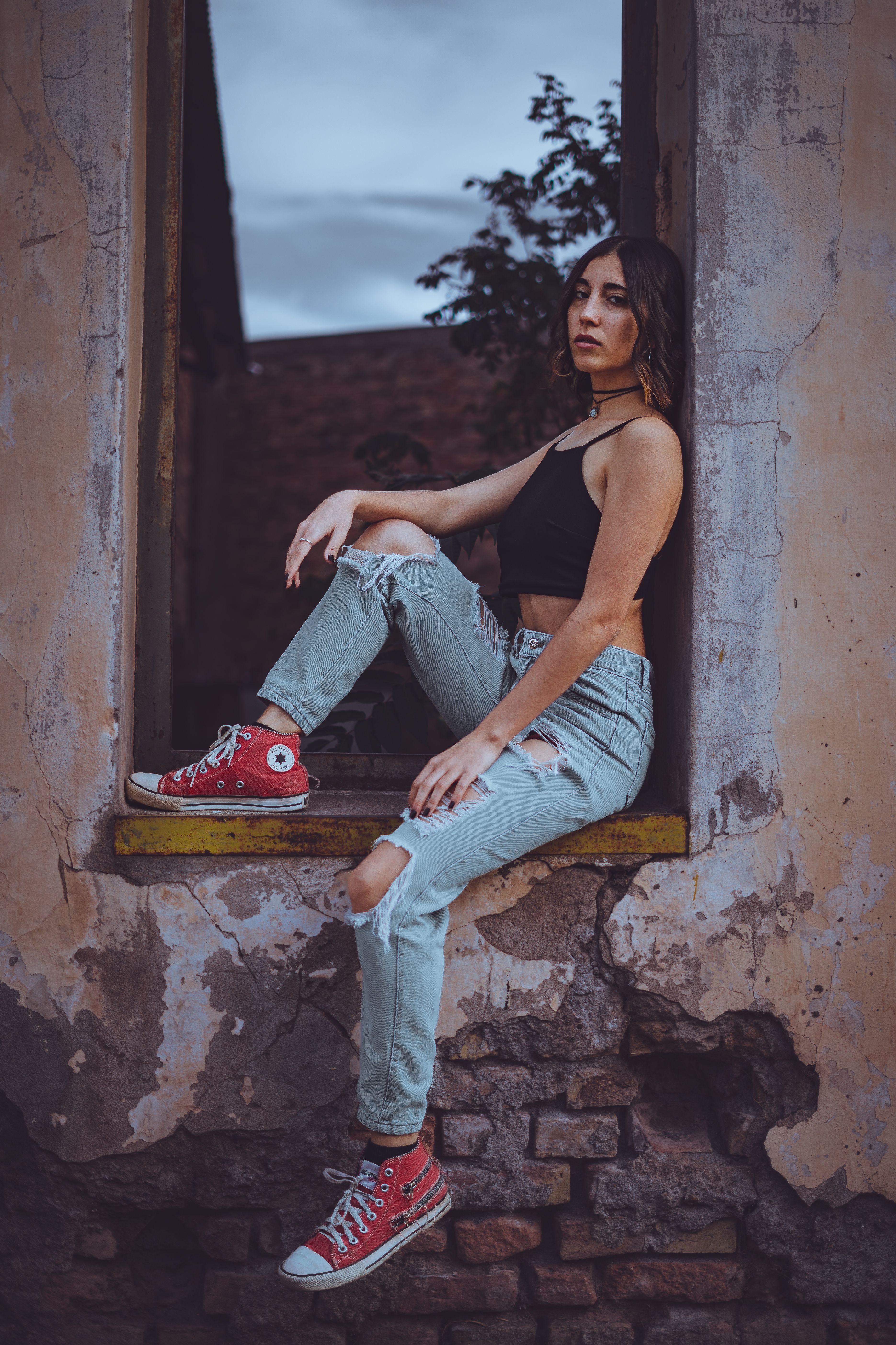 Woman Sitting in Window · Free Stock Photo