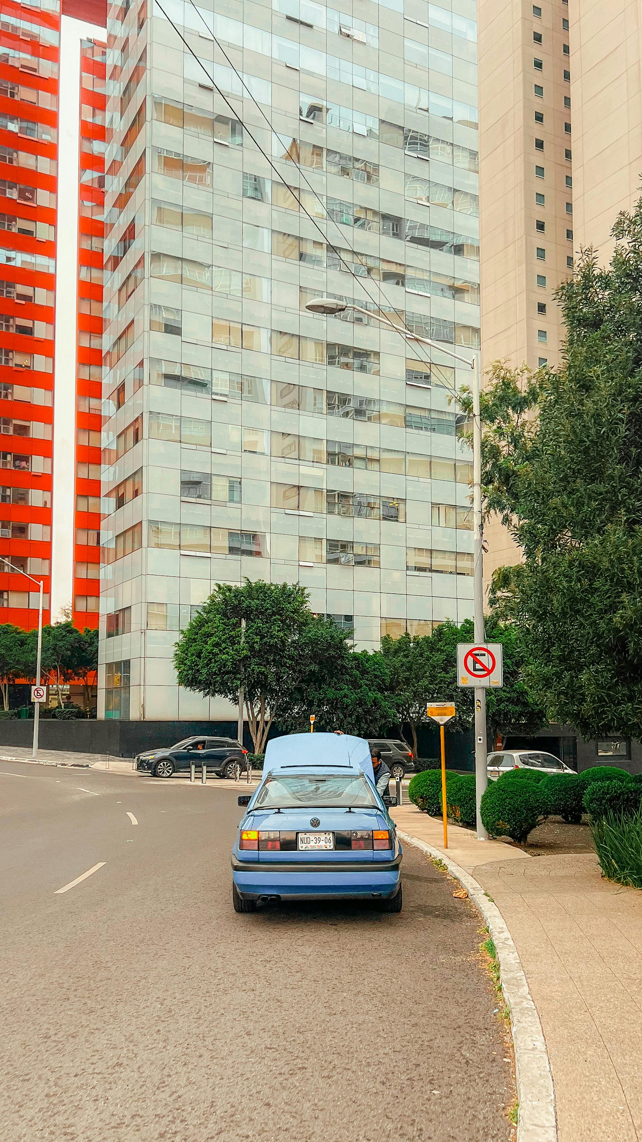Cars on Road Near Concrete Building · Free Stock Photo