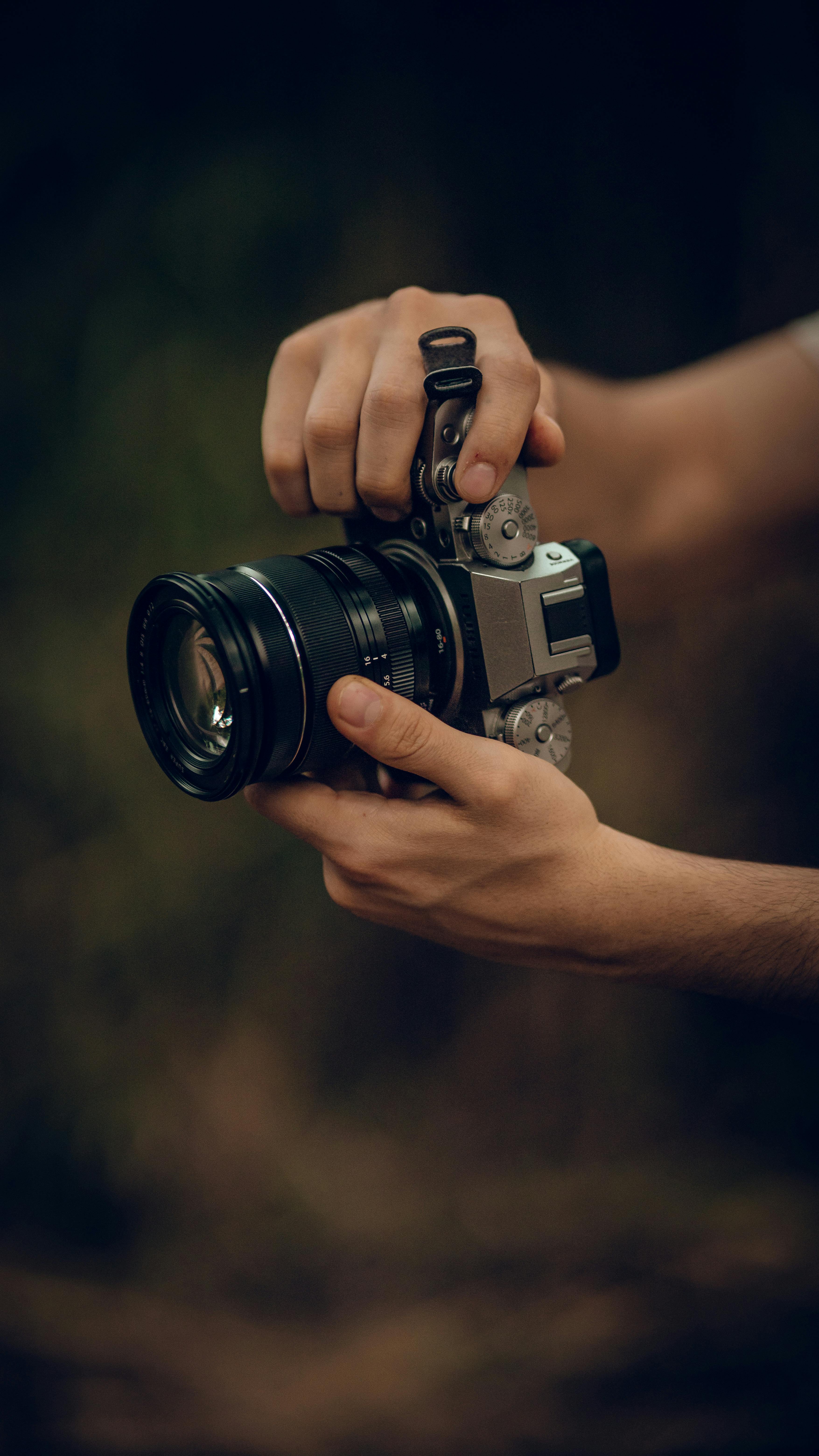 Photography of Man Holding Dslr Camera · Free Stock Photo
