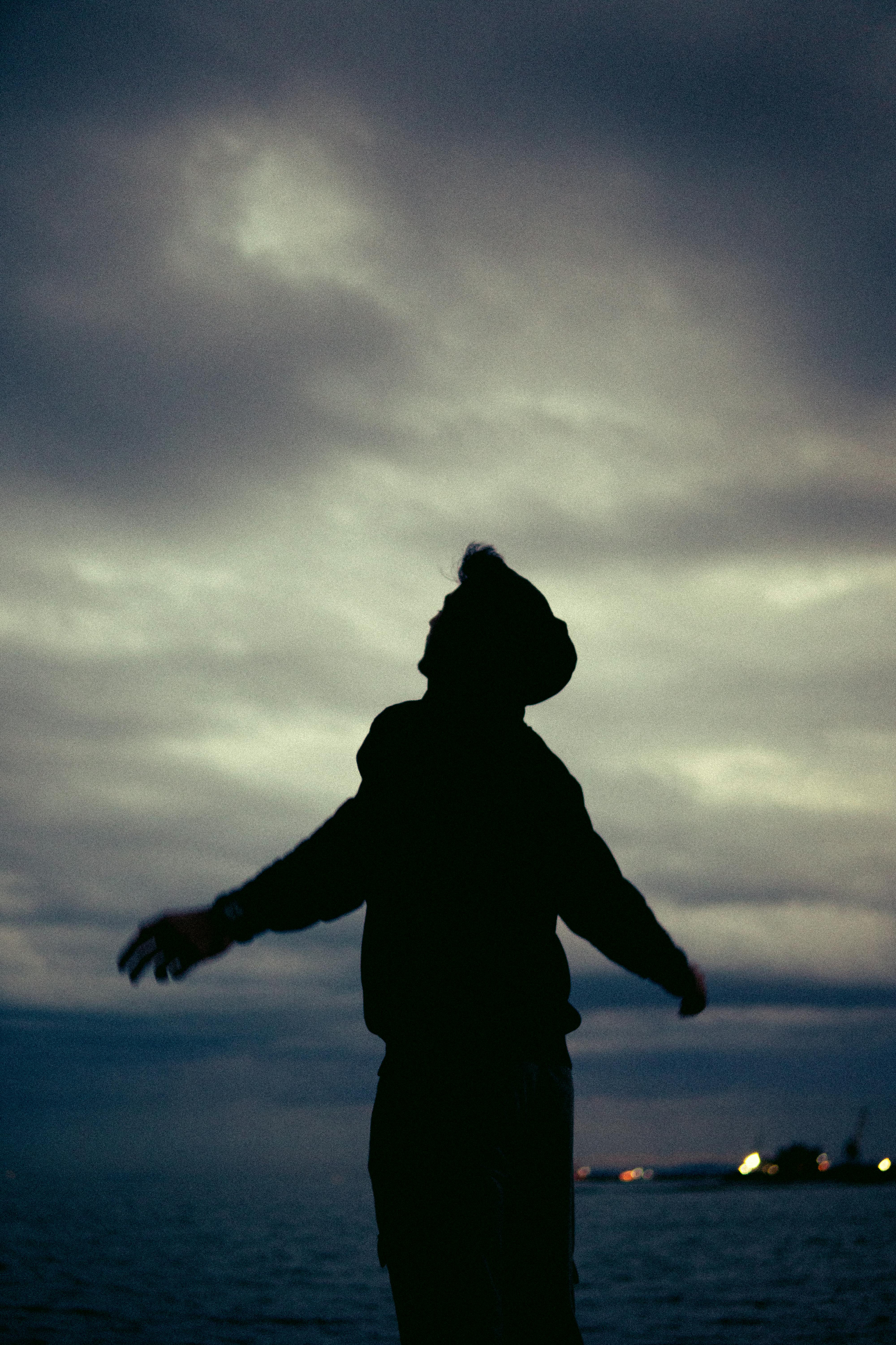 Silhouette of Woman Looking Out Window · Free Stock Photo
