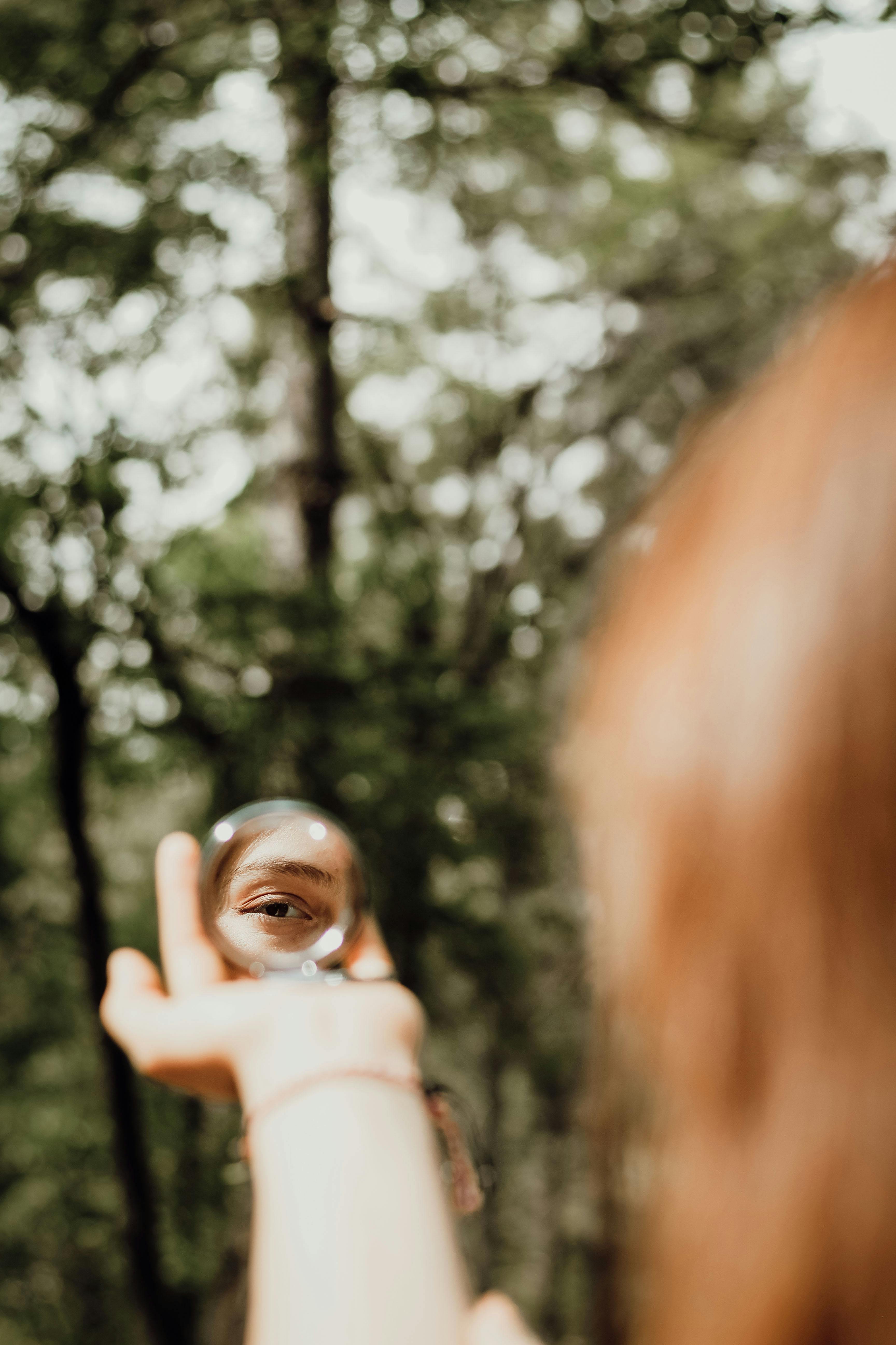 Woman Looking at her Reflection in a Mirror · Free Stock Photo