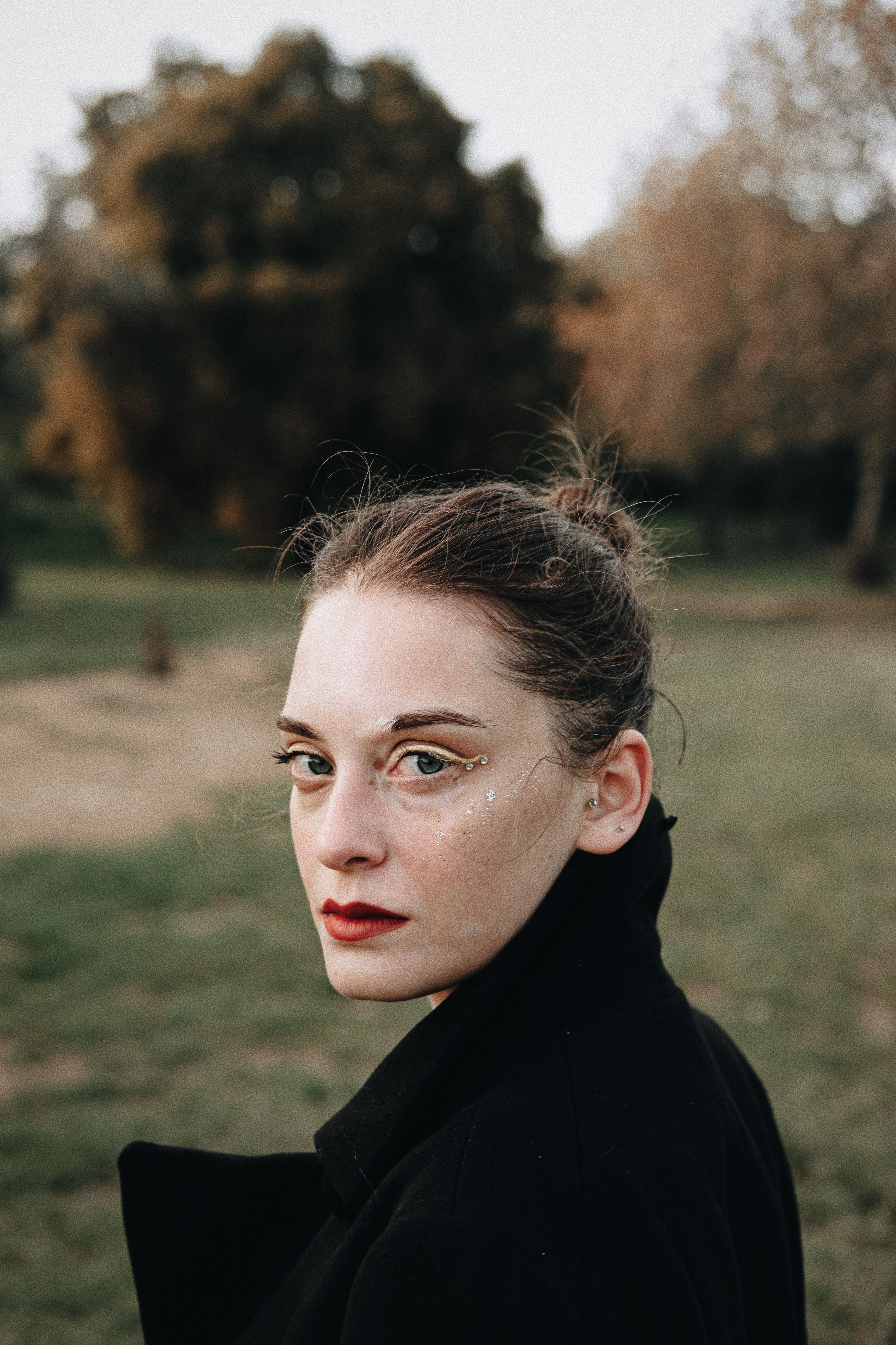 Portrait of a Pretty Brunette Looking over the Shoulder at the Camera ...