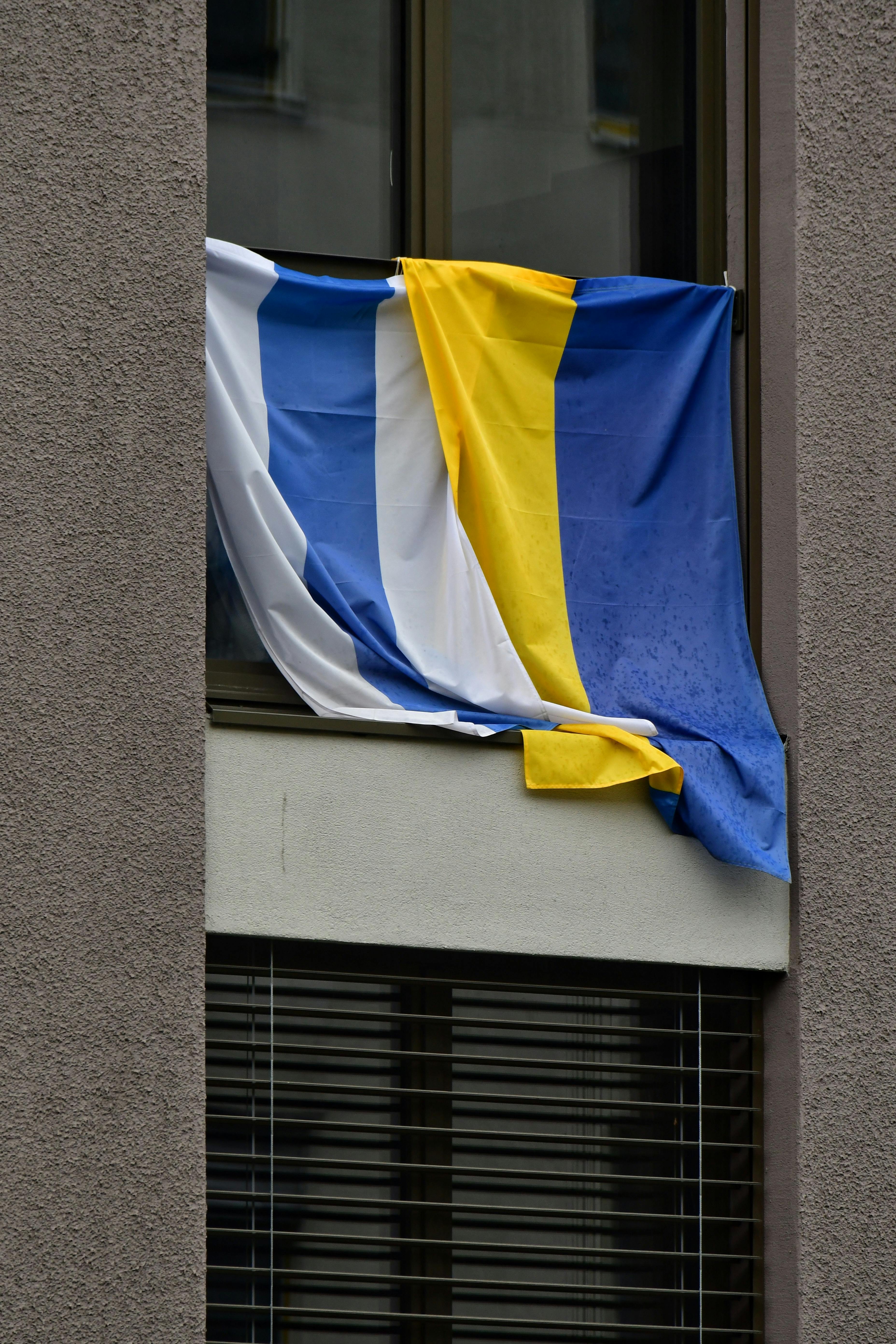 Flags on Building Windows · Free Stock Photo