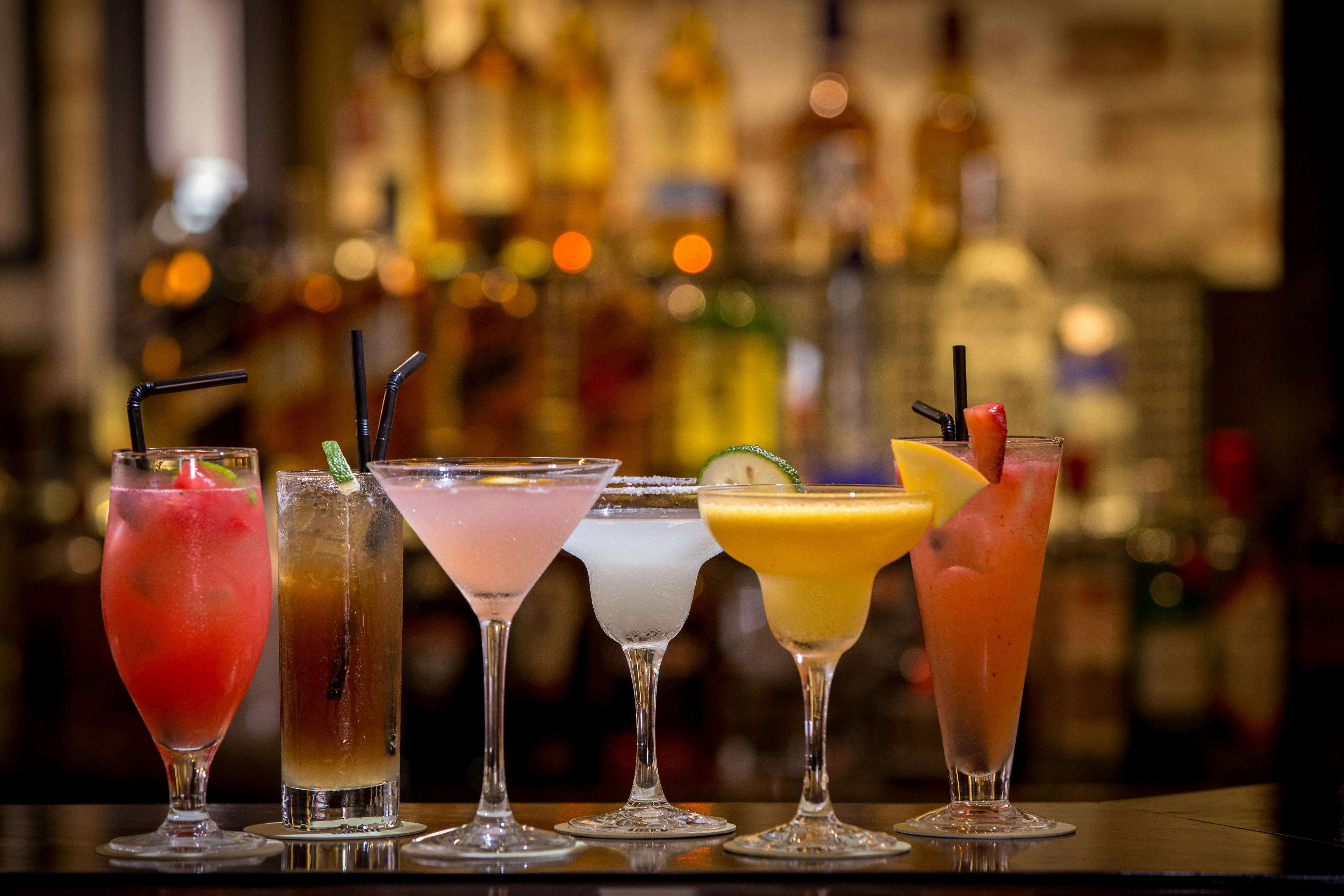 Colorful Cocktails Standing in Line on Bar Counter · Free Stock Photo