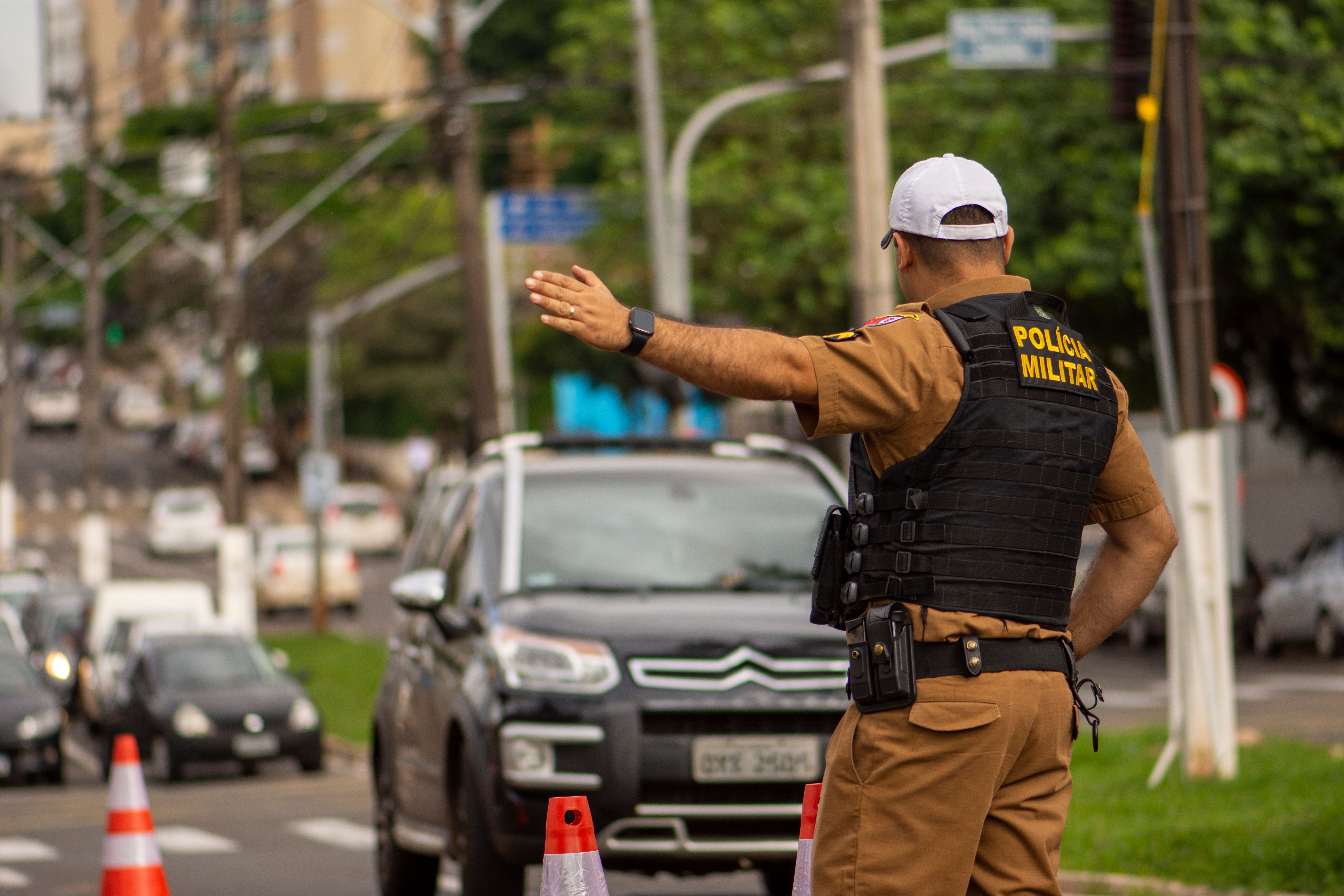 A Police Officer Coordinating the Traffic in City · Free Stock Photo
