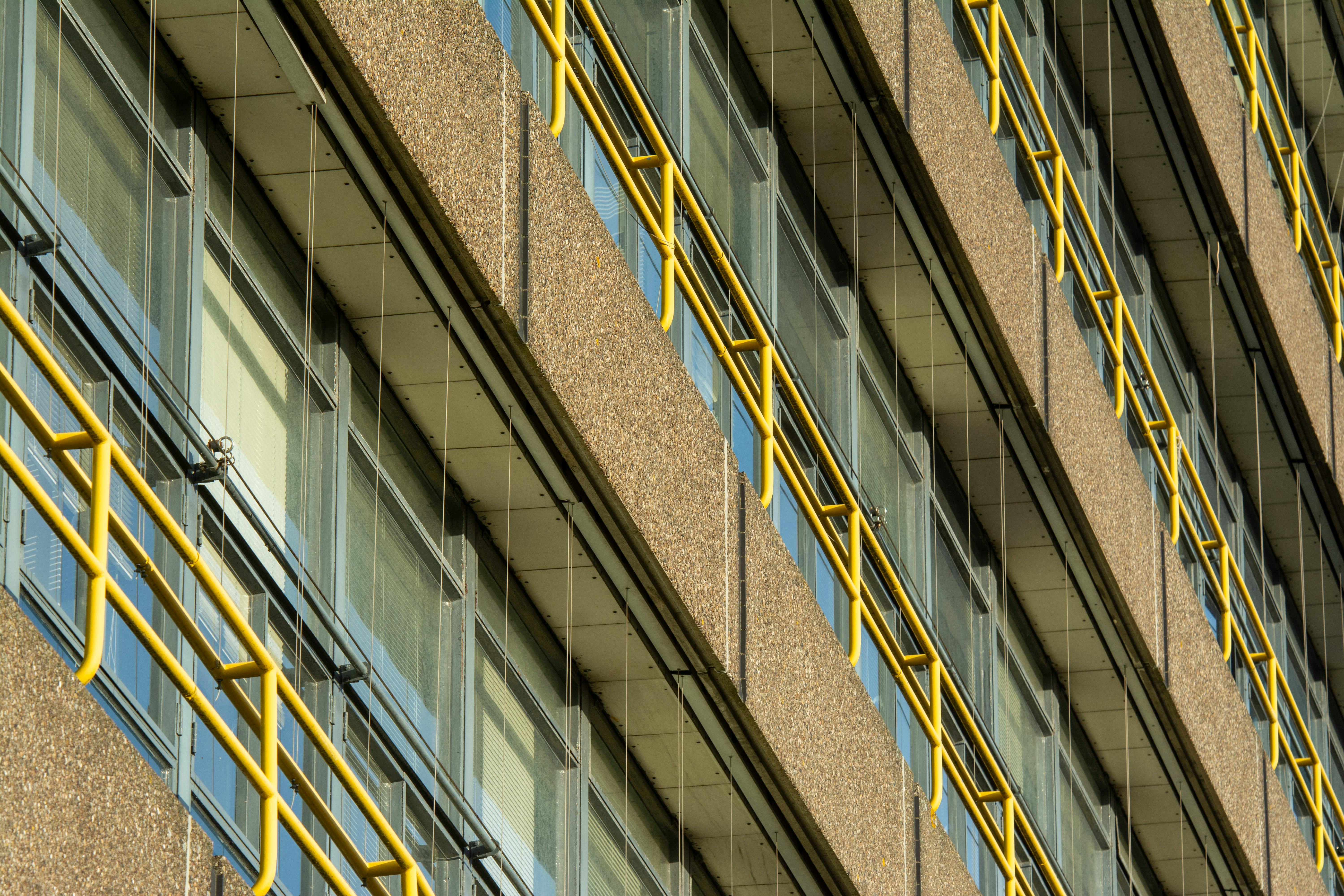 Yellow Railings by Windows on Building Exte · Free Stock Photo
