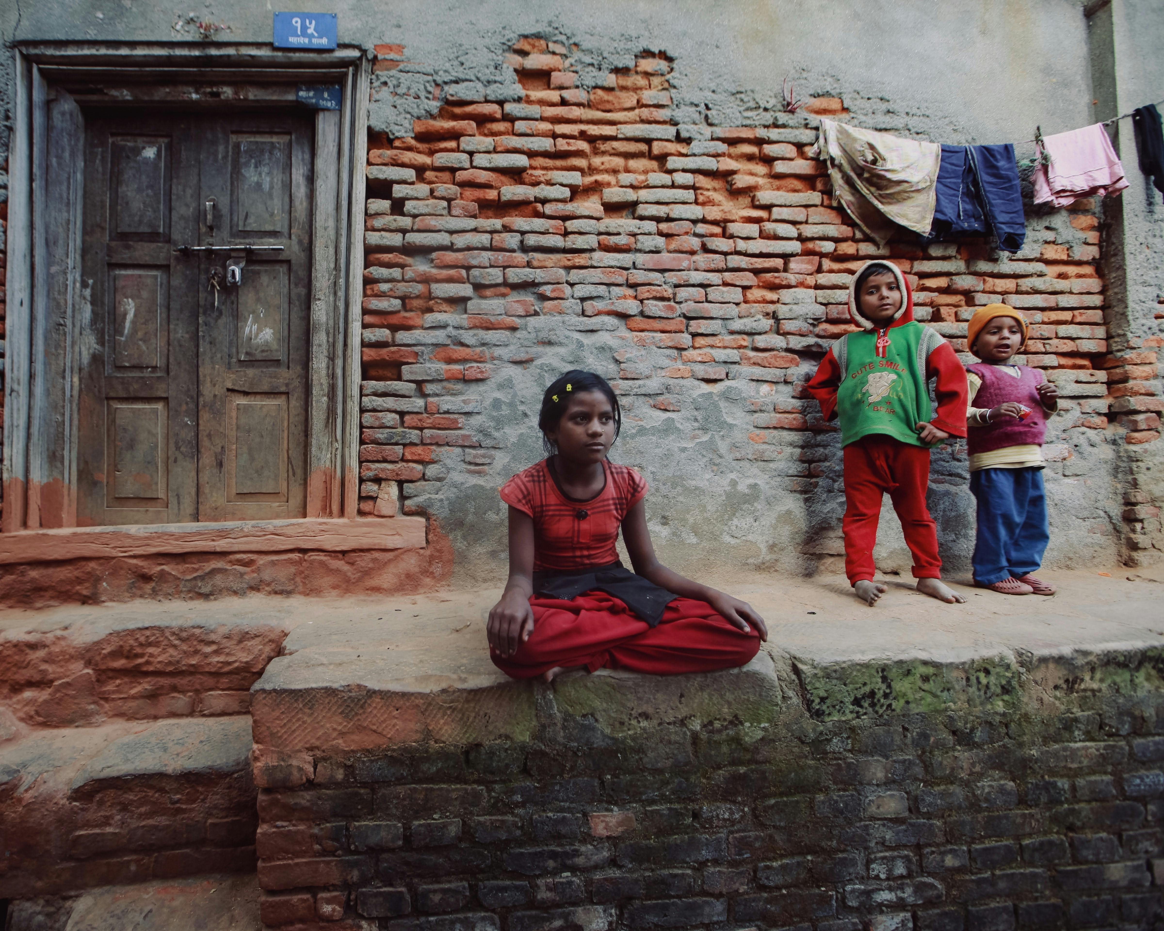 Children near Building Door in Village · Free Stock Photo