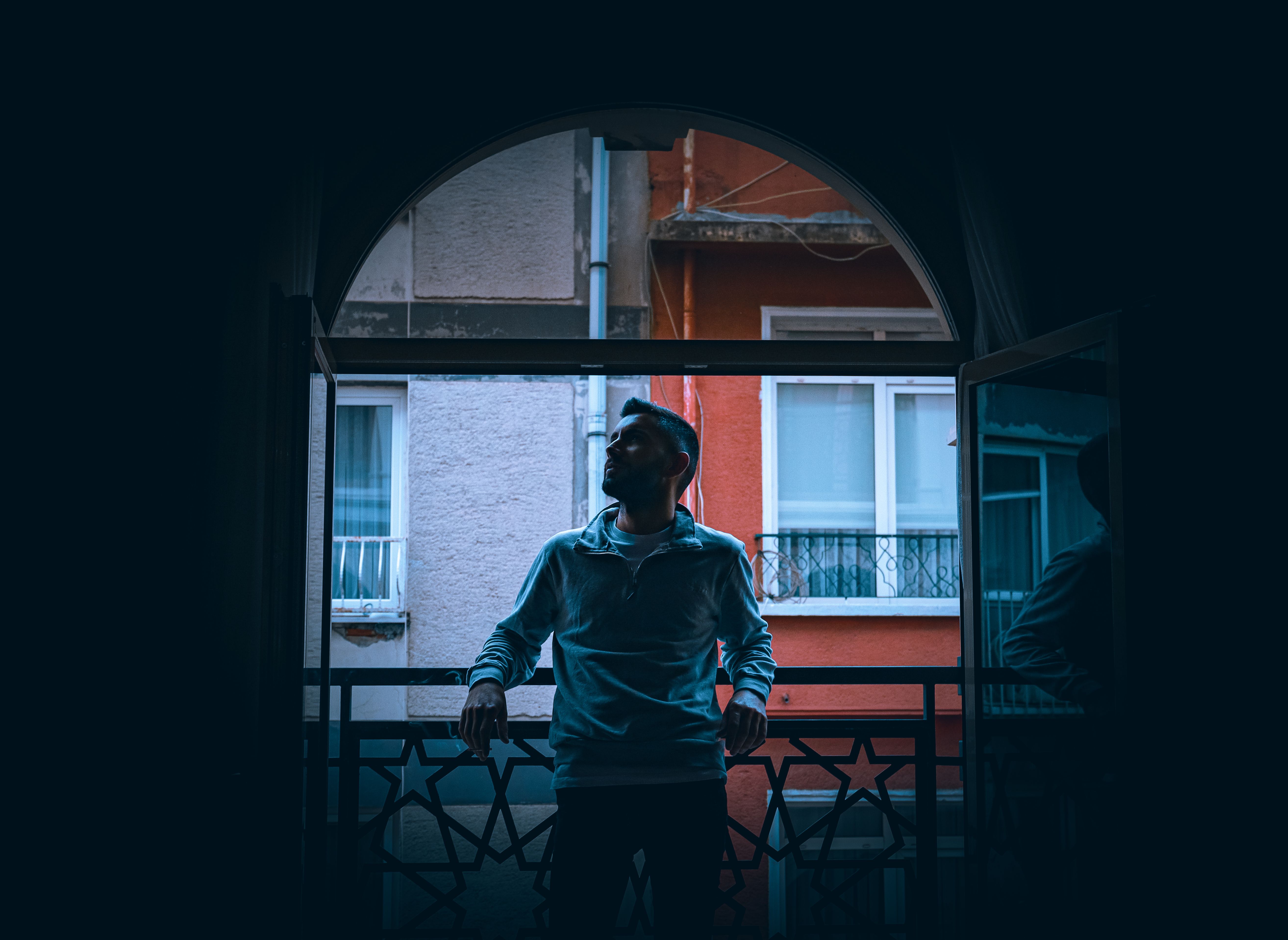 Man Standing on Balcony · Free Stock Photo