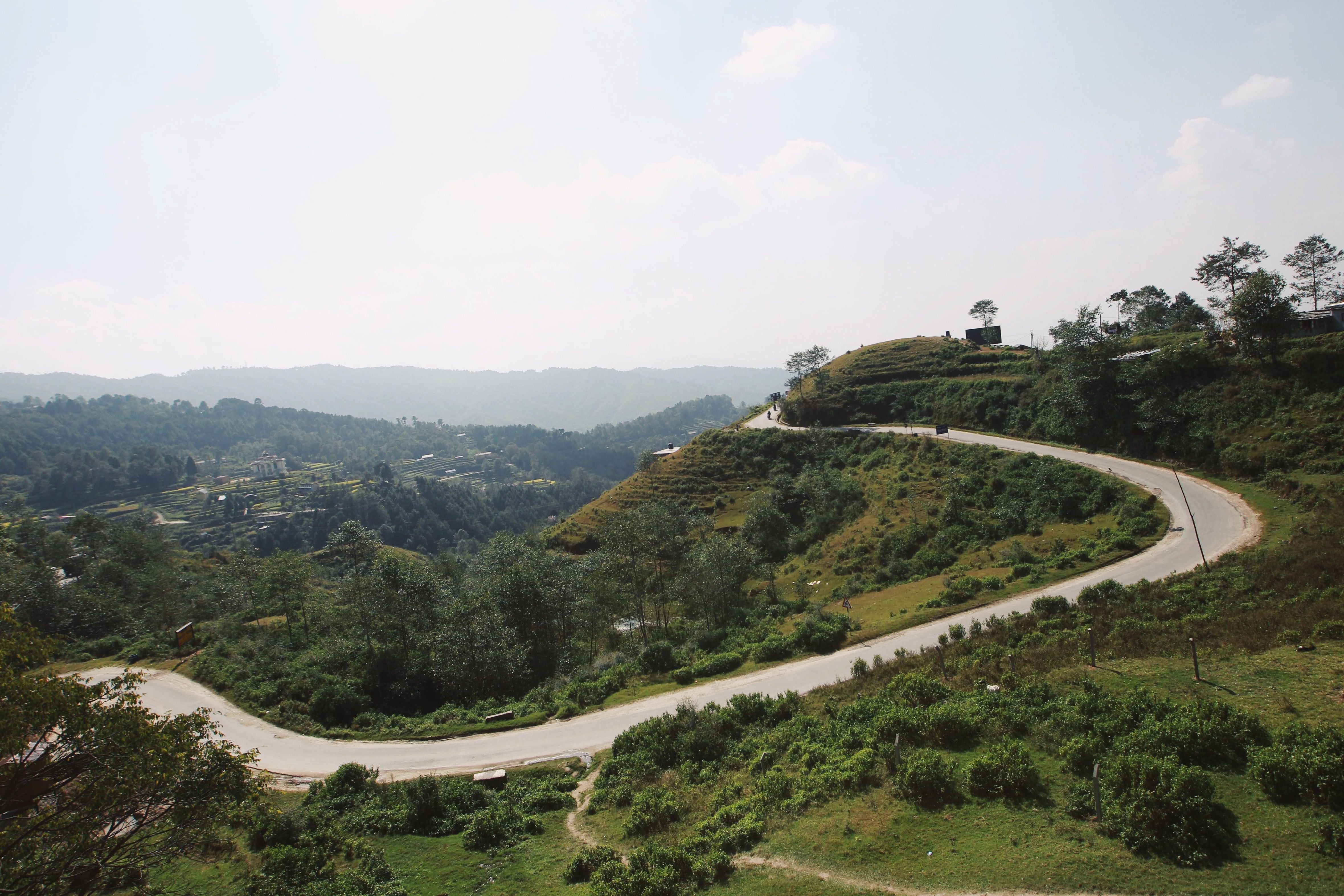 Rolling Landscape and a Road up the Hill · Free Stock Photo