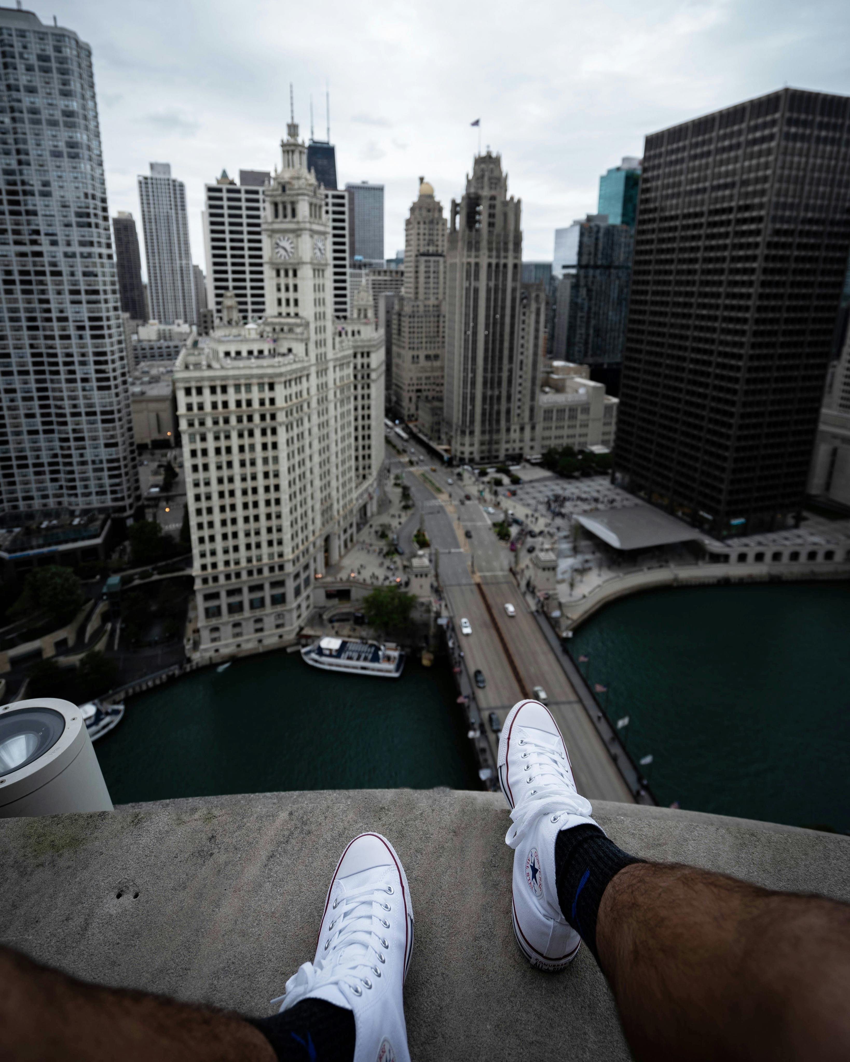 Person Sitting On Building Rooftop · Free Stock Photo
