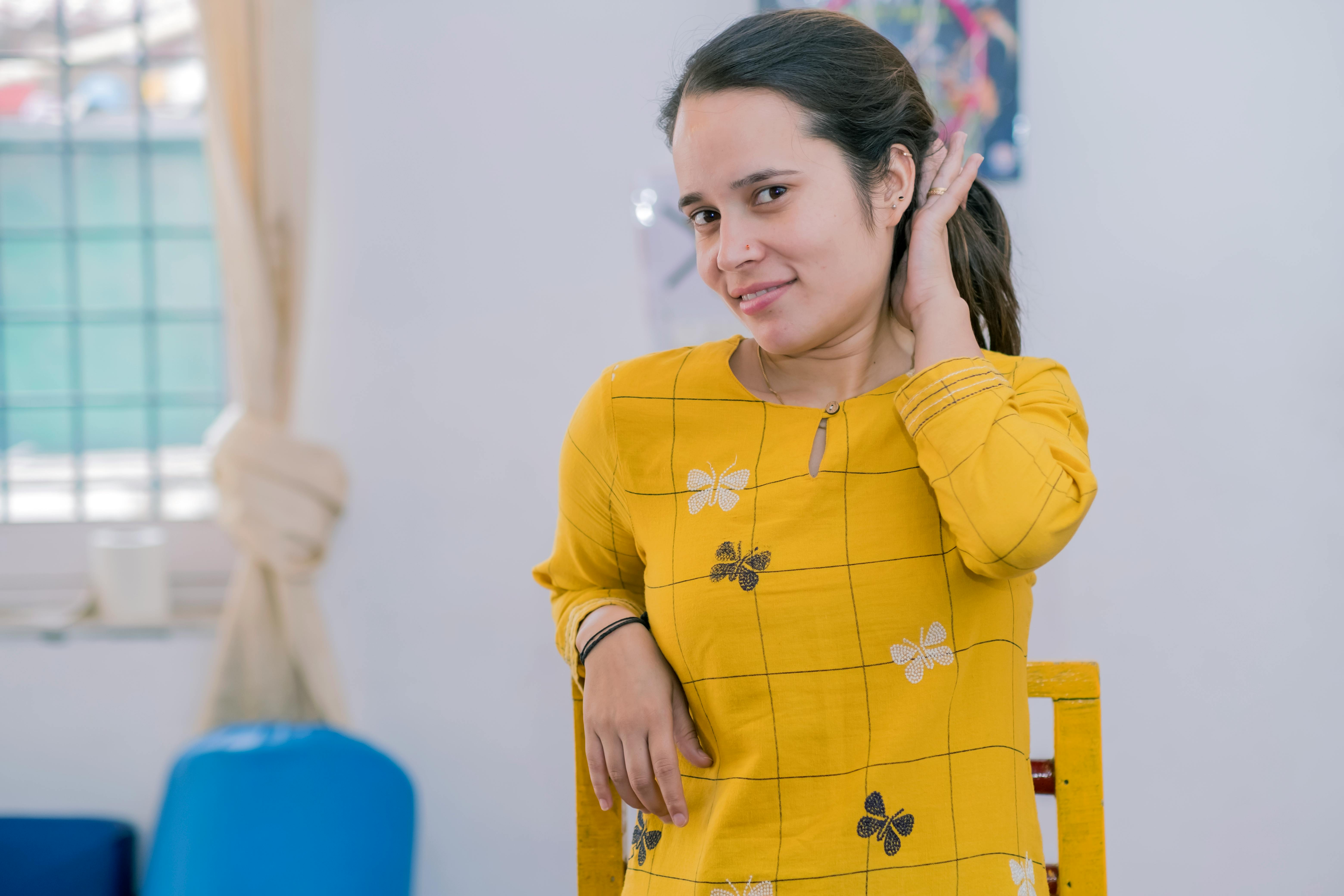 Woman Sitting in Yellow Clothes · Free Stock Photo