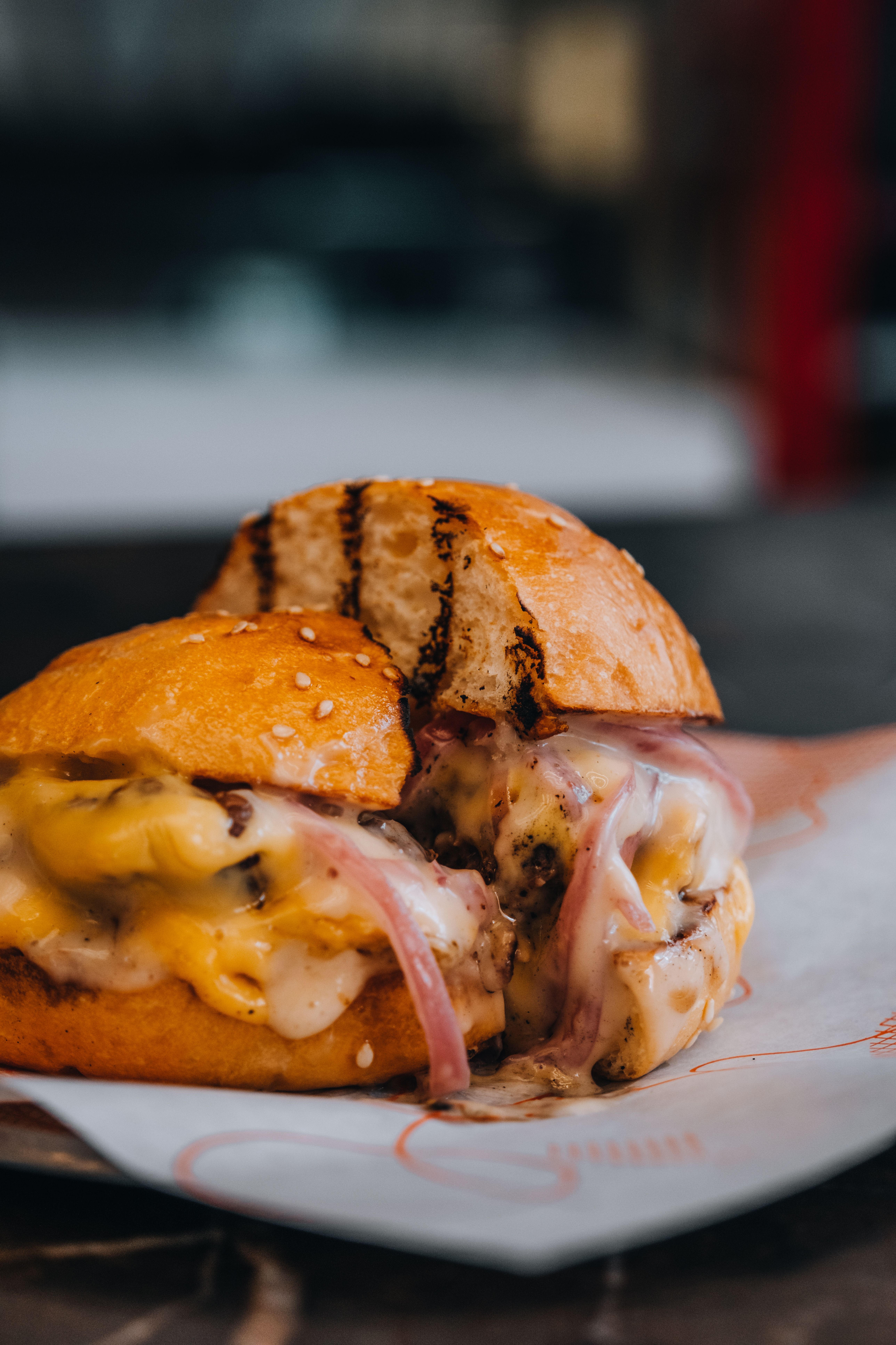 Close-up of a Burger with a Lot of Melted Cheese · Free Stock Photo