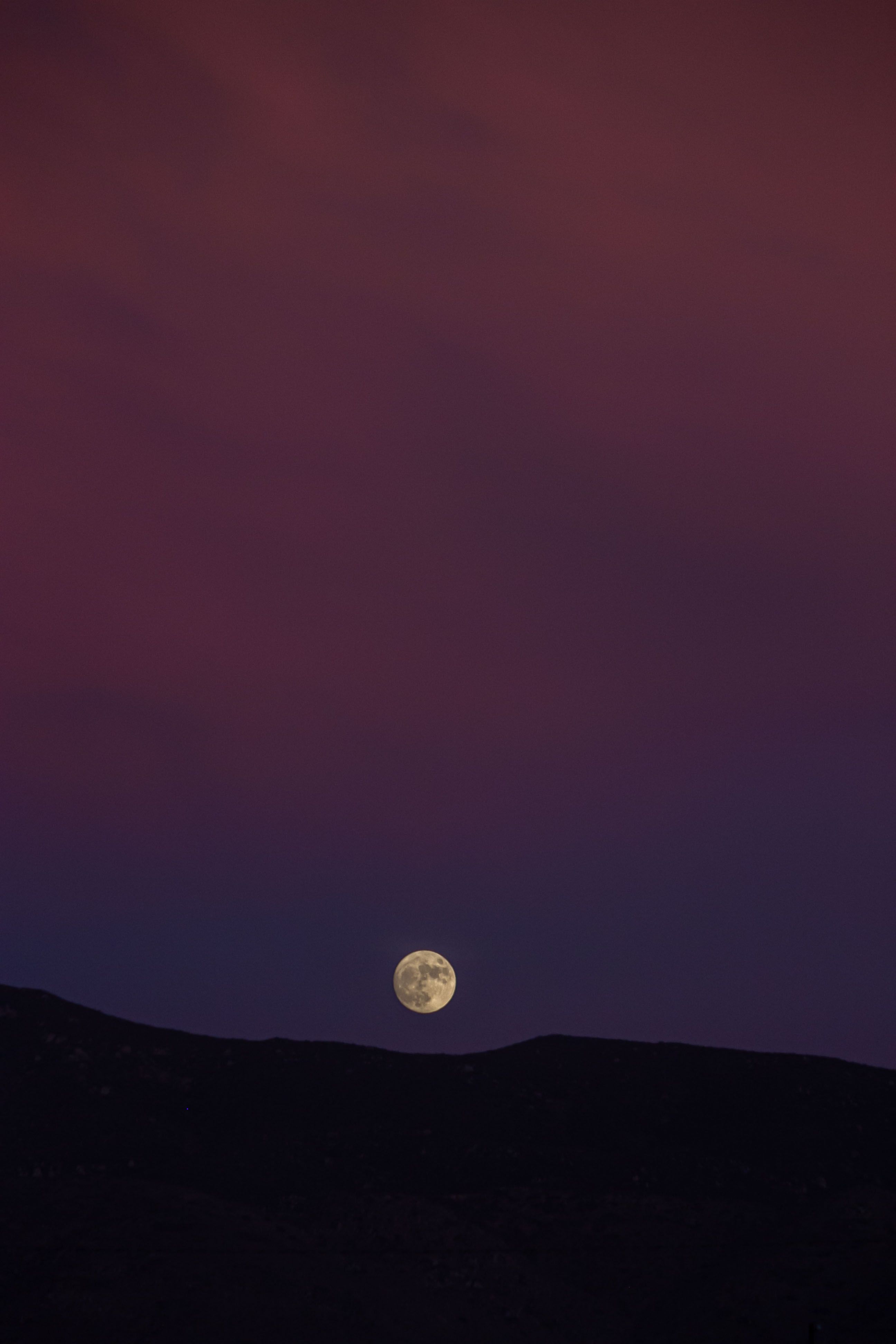 Moon over the Silhouette of a Hill · Free Stock Photo