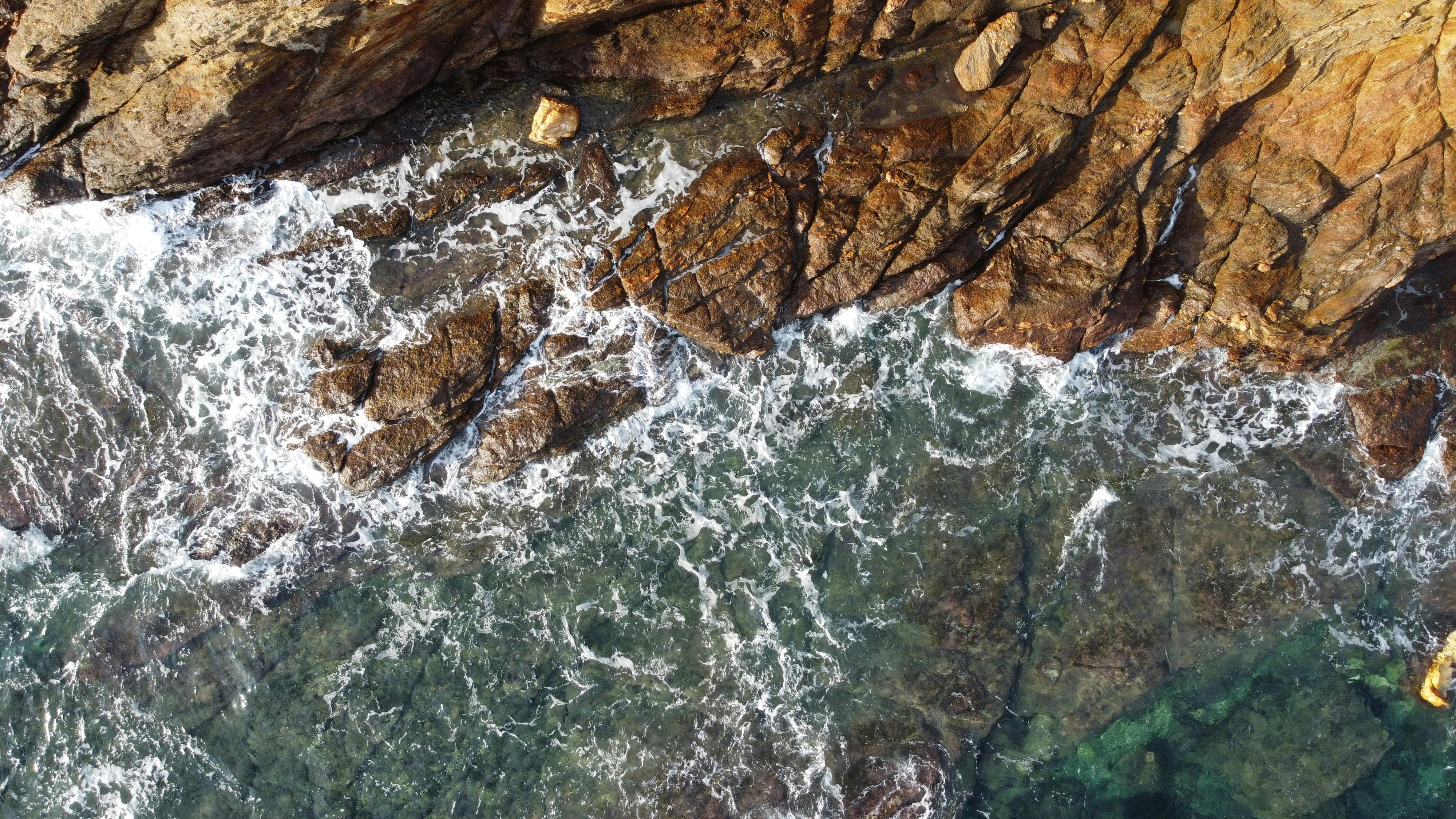 Top View Photo of Rocky Shore · Free Stock Photo