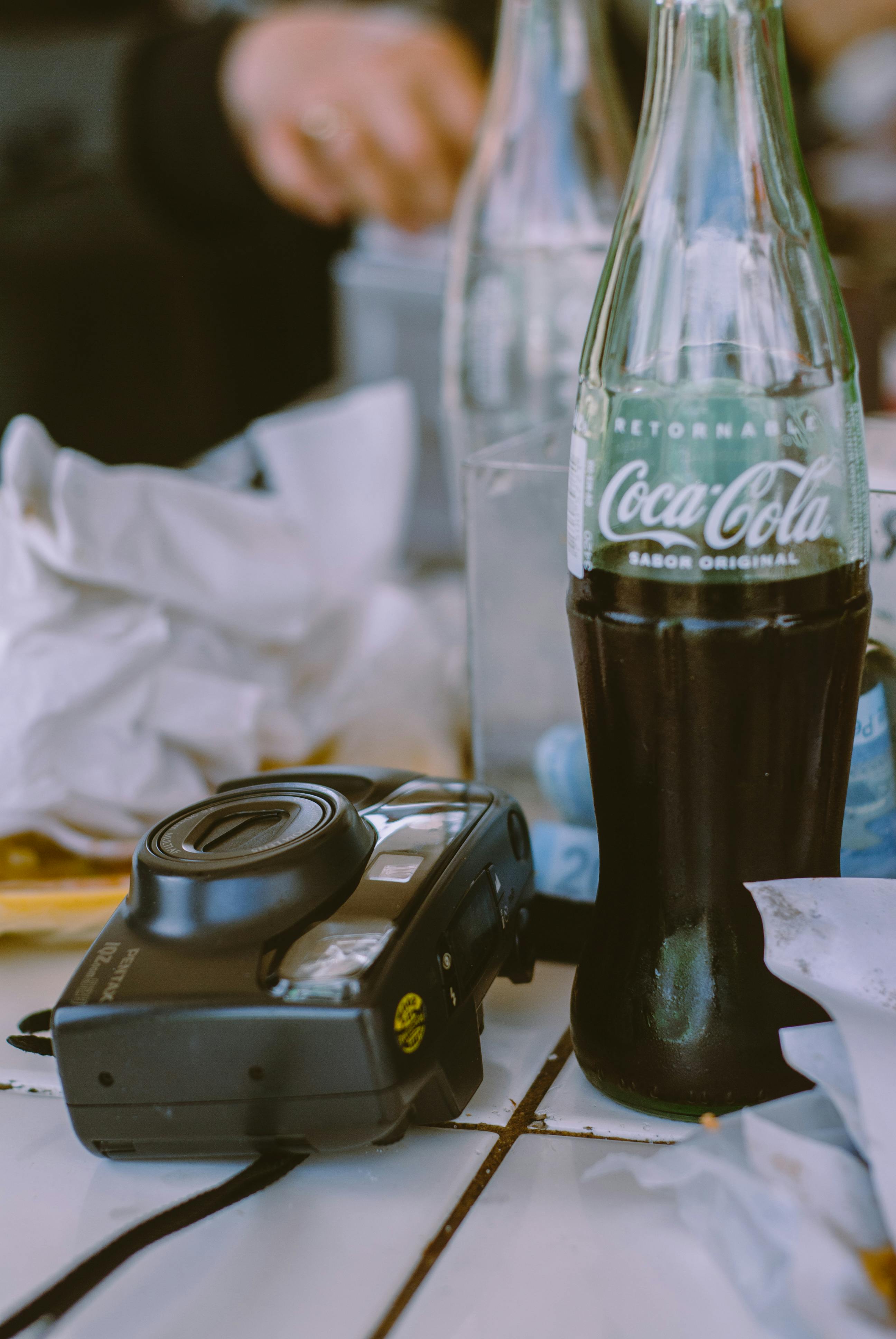 Camera and Coca Cola · Free Stock Photo