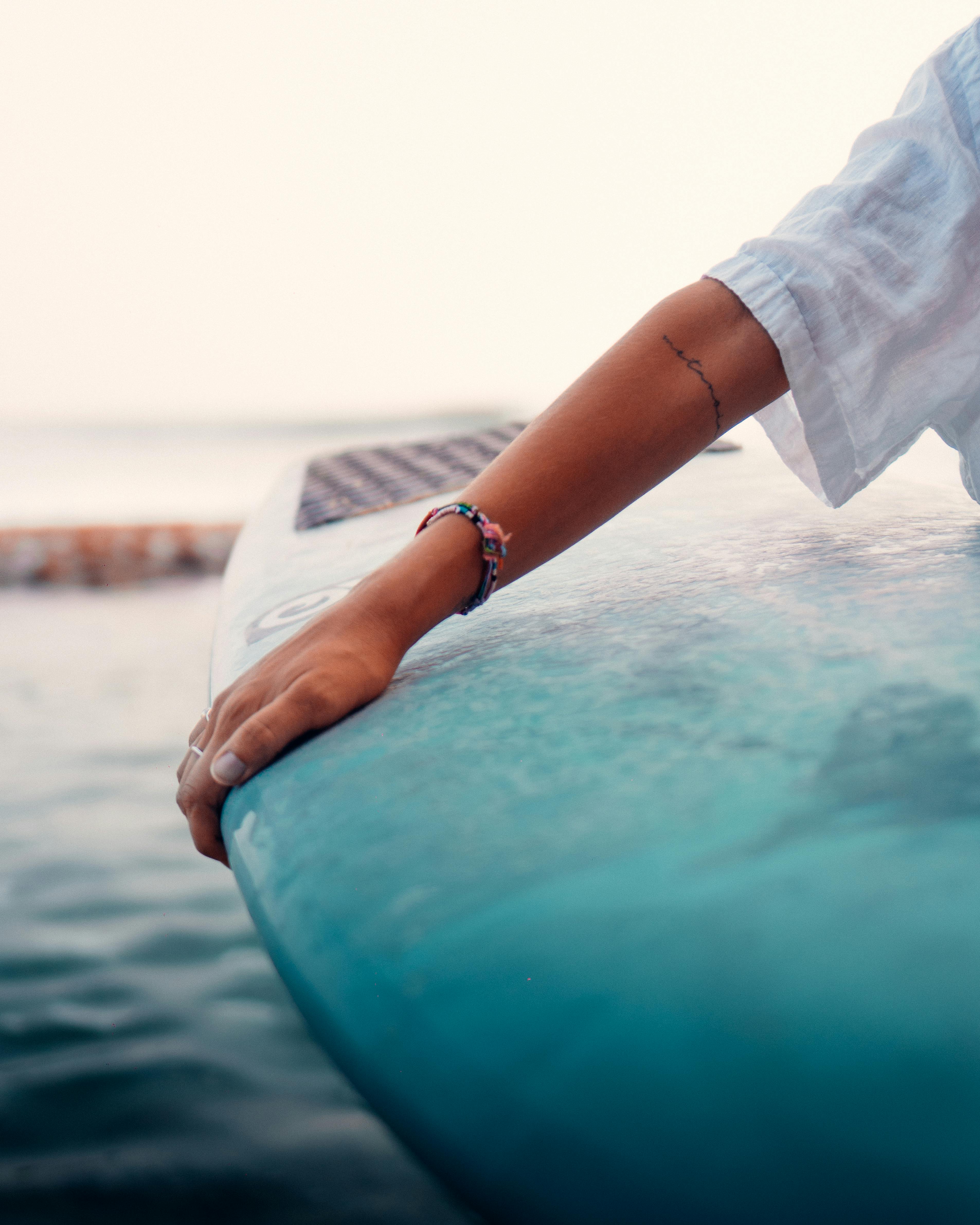 Woman Hand Holding Surfboard · Free Stock Photo