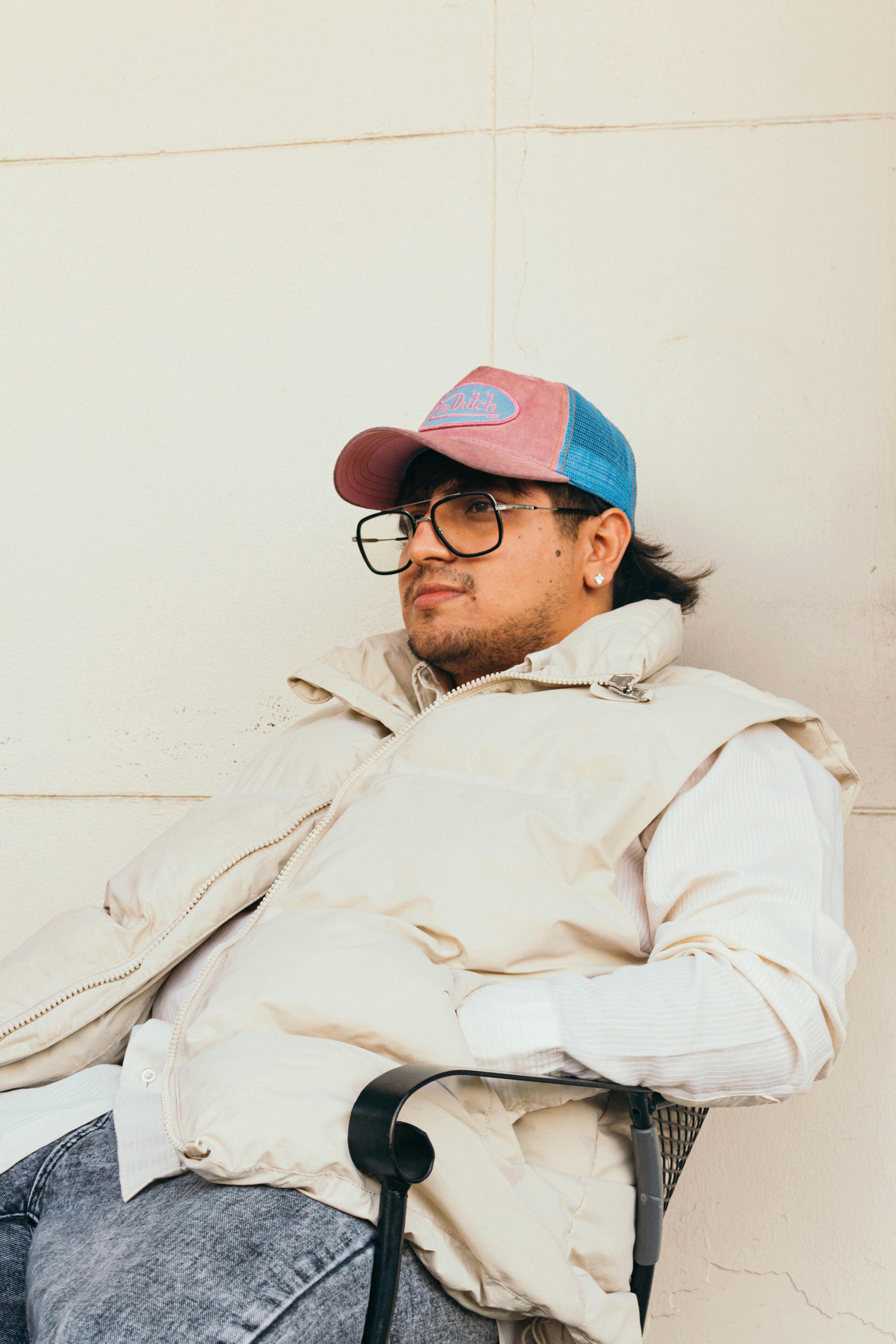 Man Posing in Cap and Jacket · Free Stock Photo