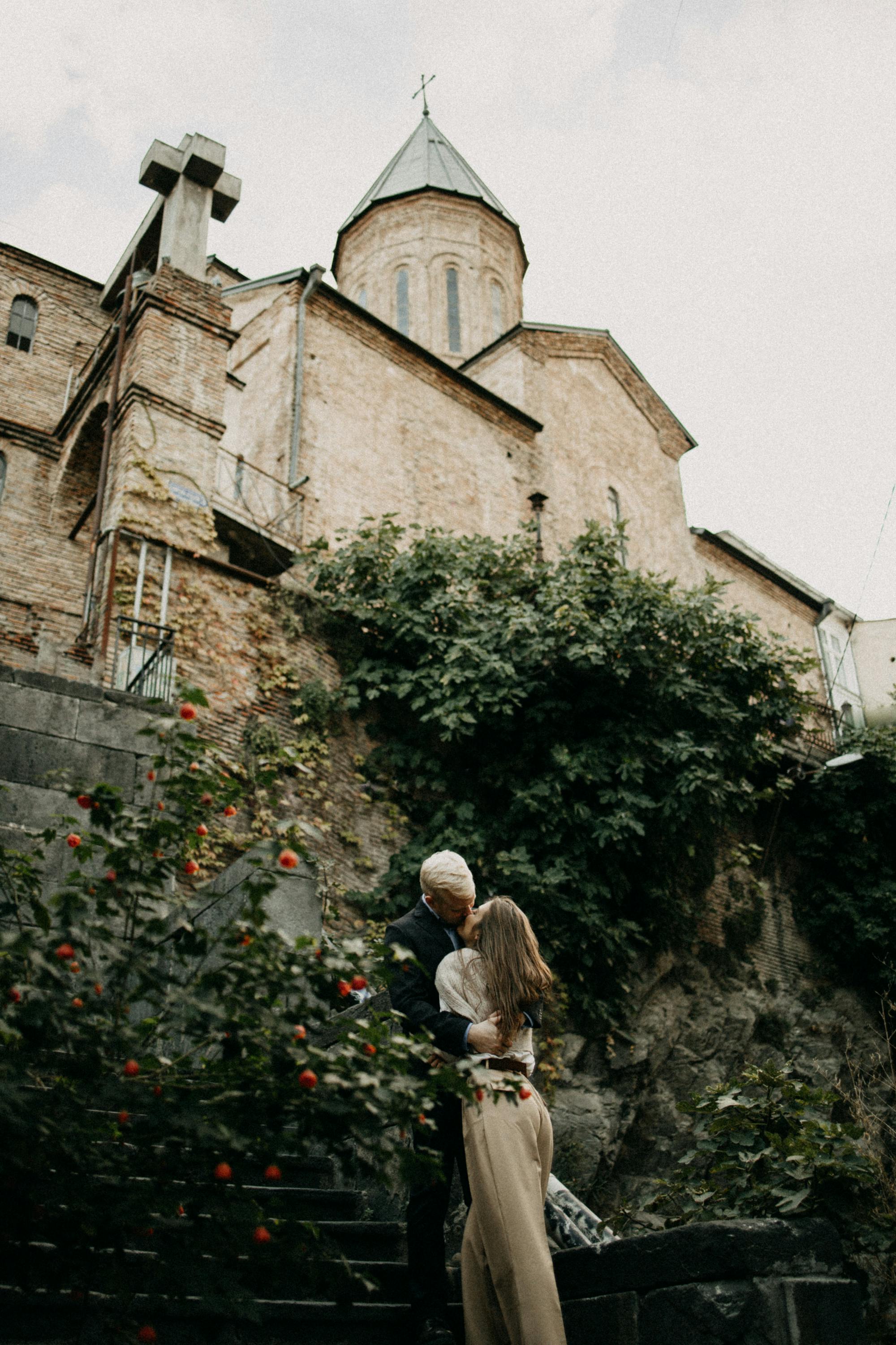 A Couple Kissing in front of a Castle · Free Stock Photo