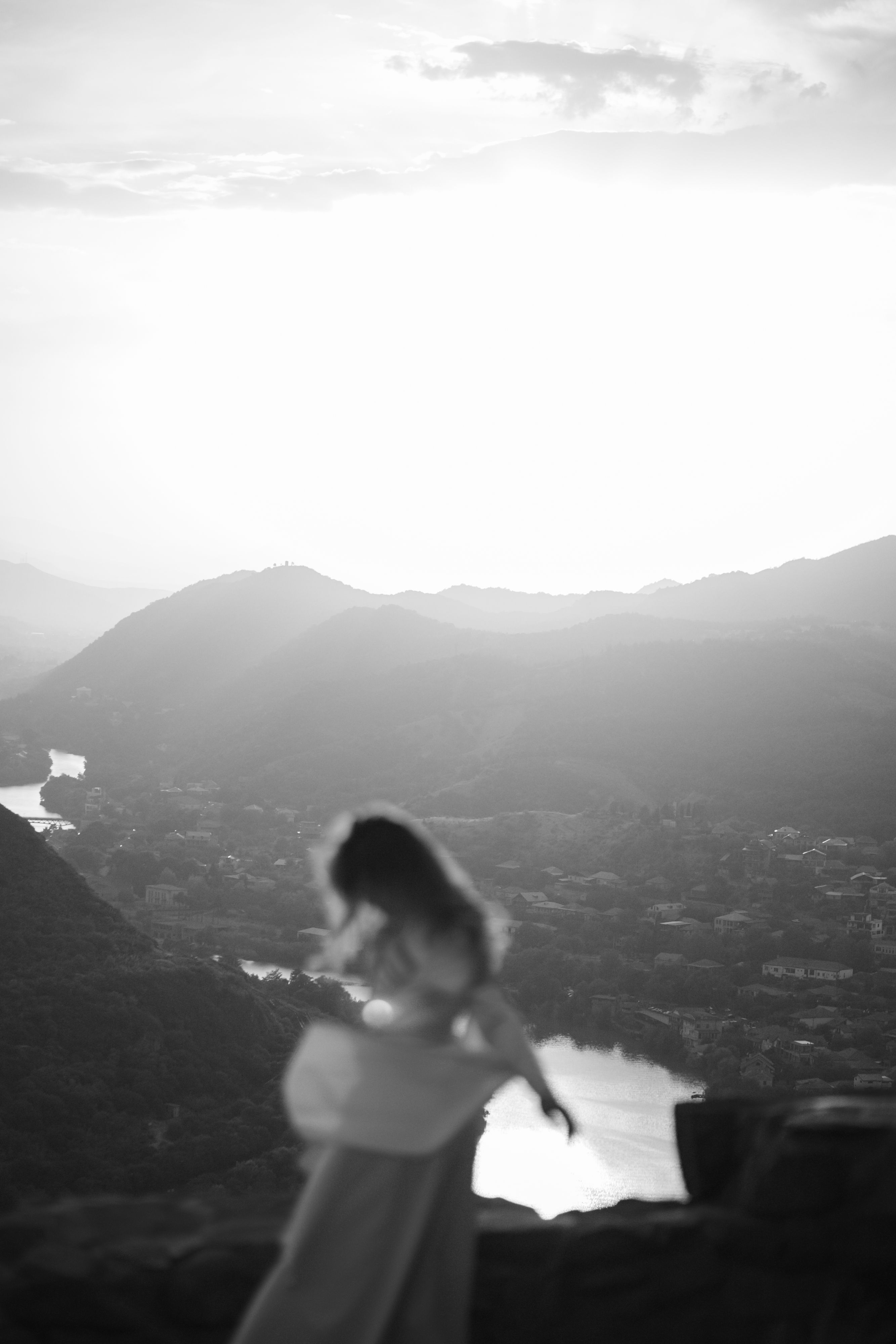 Sunlight over Posing Woman with Town and Mountains behind · Free Stock ...