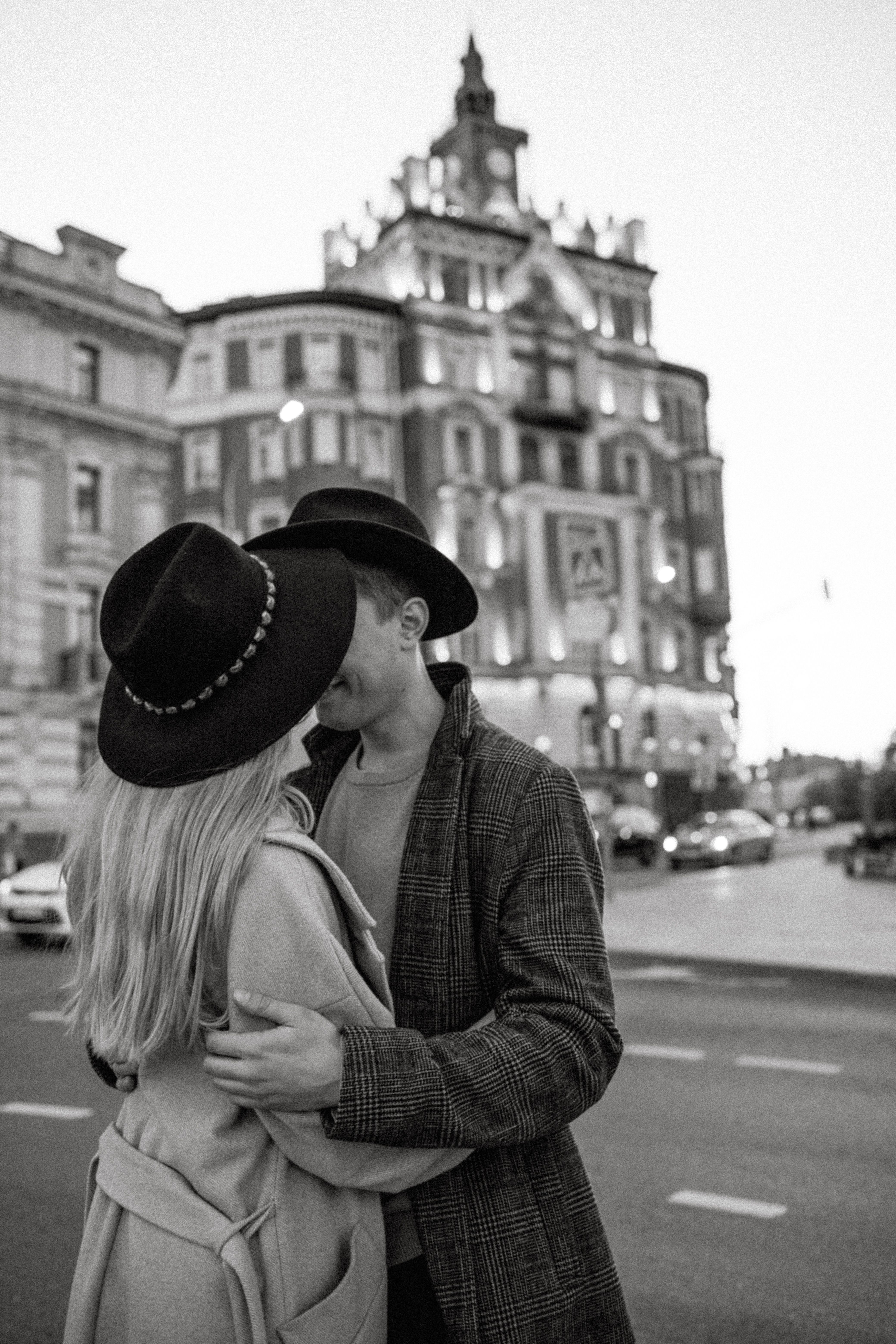 Couple in Hats Kissing near Street in City in Black and White · Free ...