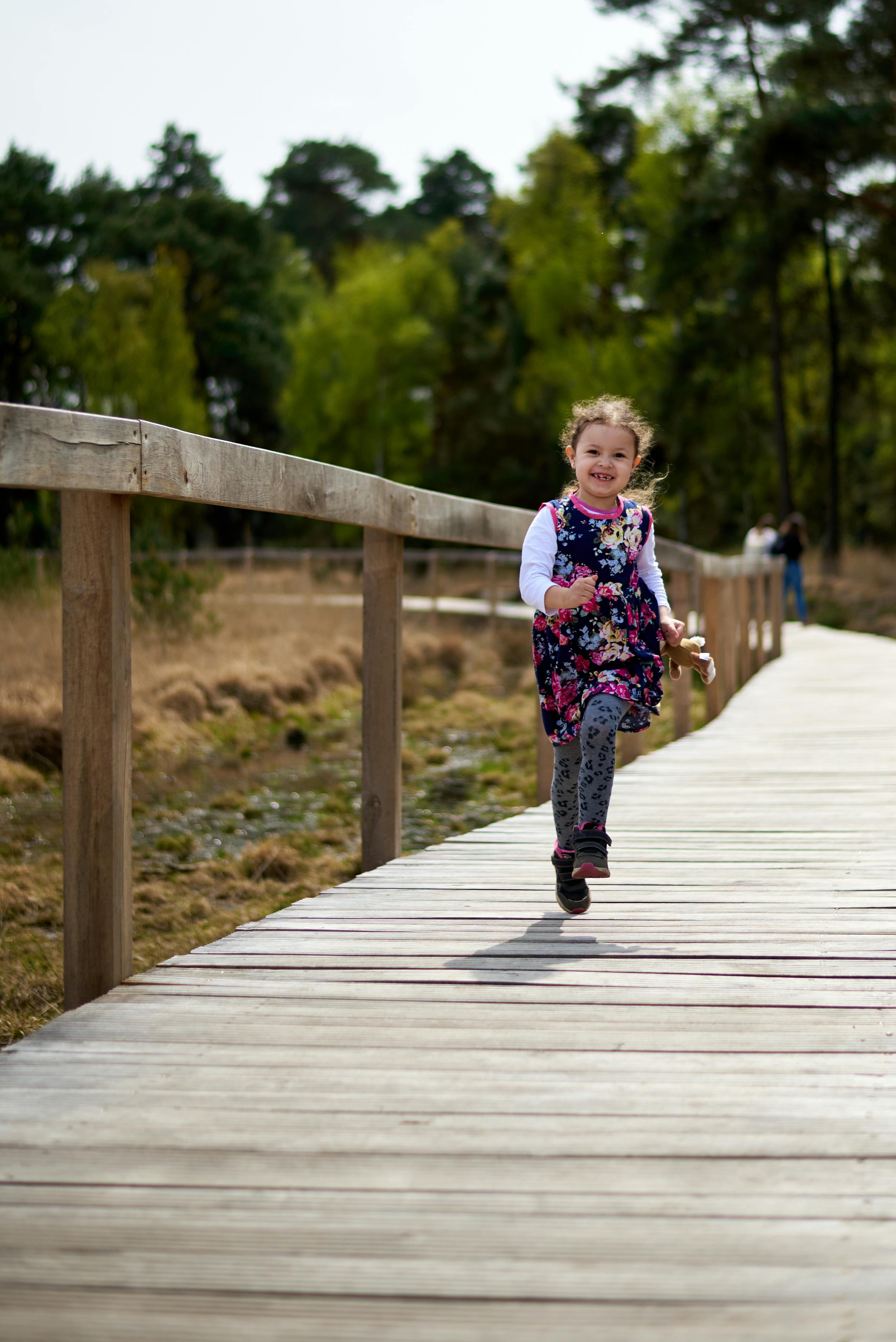 Girl in White Dress Walking on Wooden Floor · Free Stock Photo