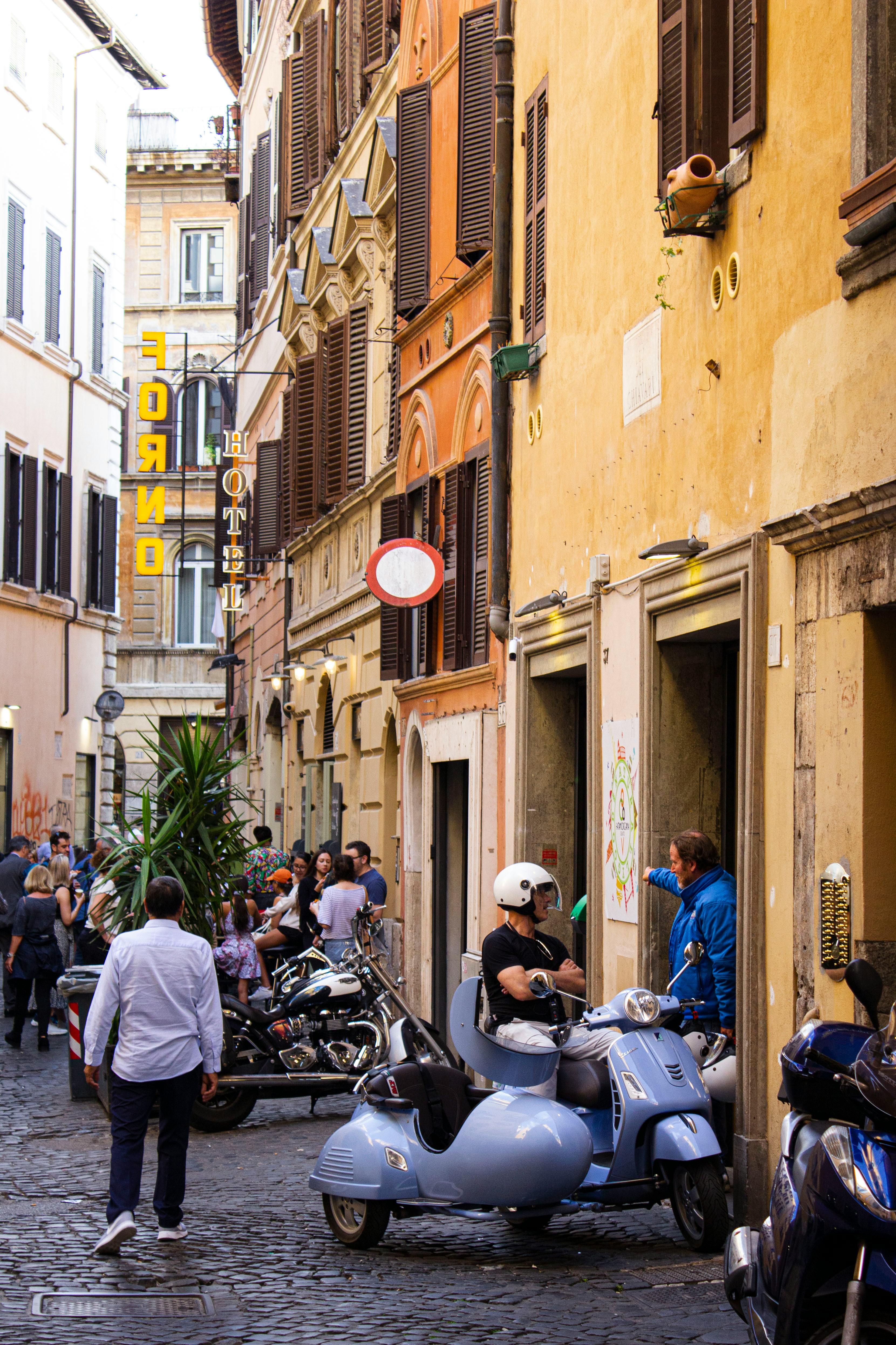Busy narrow paved street with people · Free Stock Photo