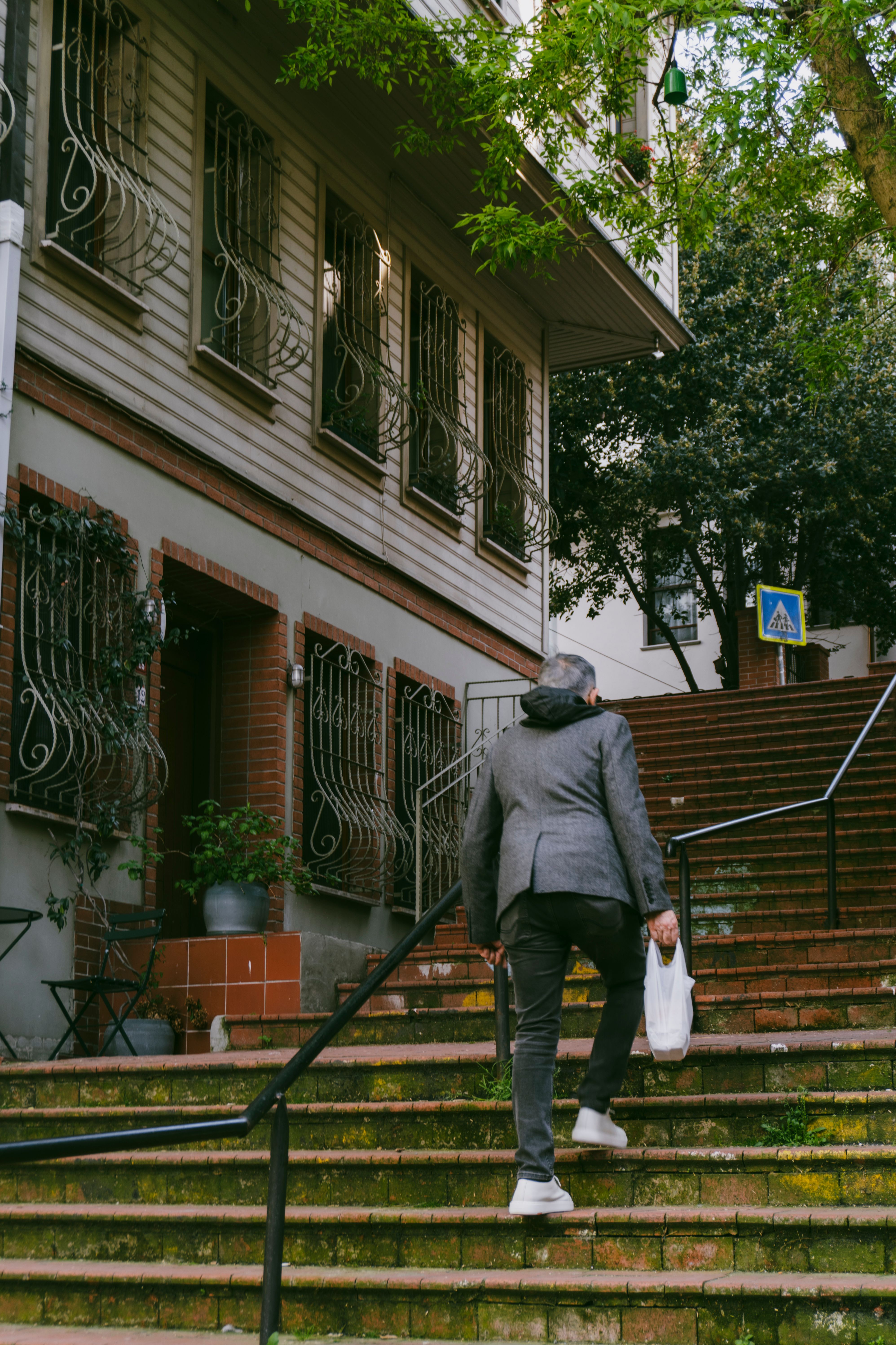 Back View of a Man Walking Up the Stairs · Free Stock Photo